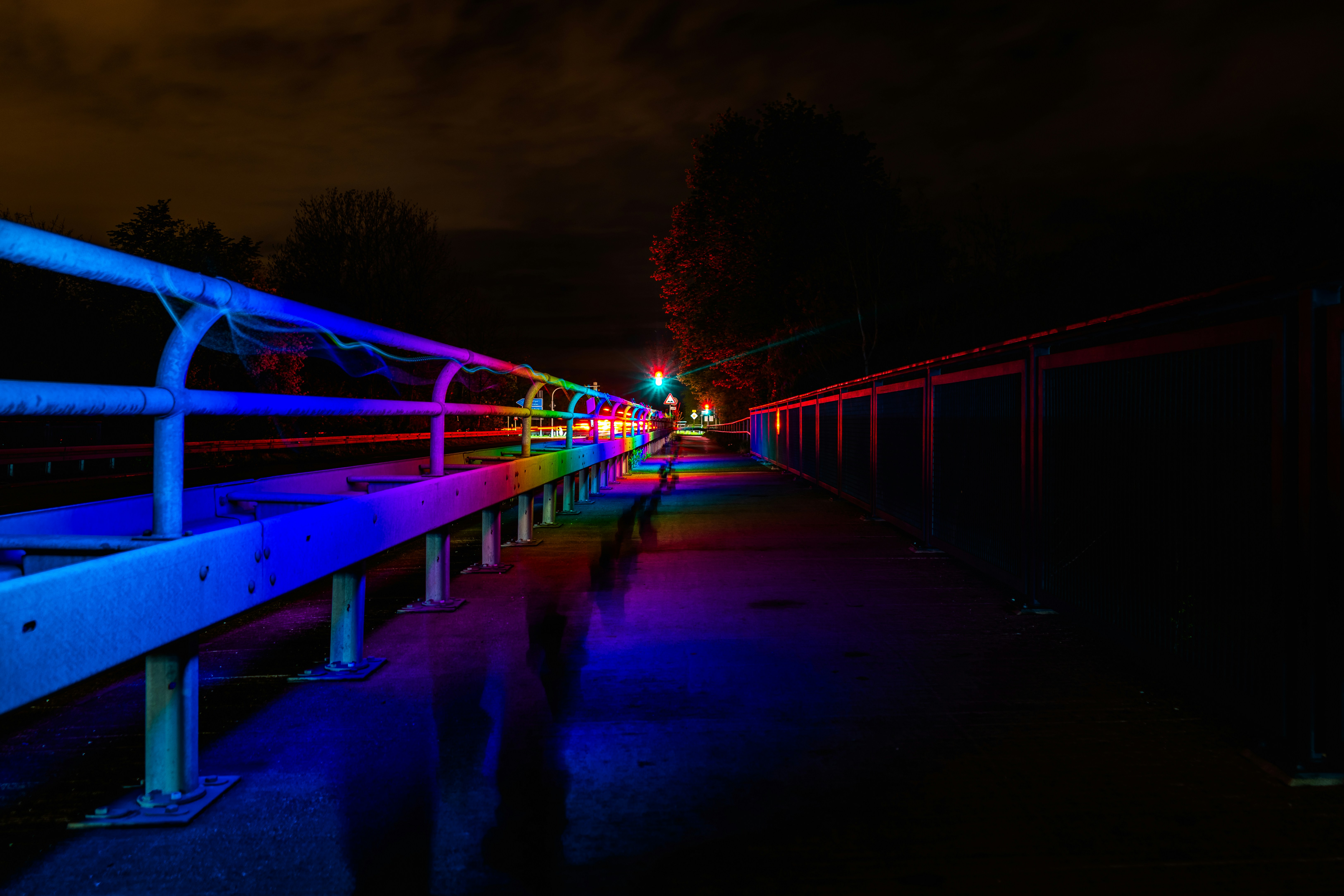 Rainbow Rails at Night: Neon Path and Ghostly Silhouettes