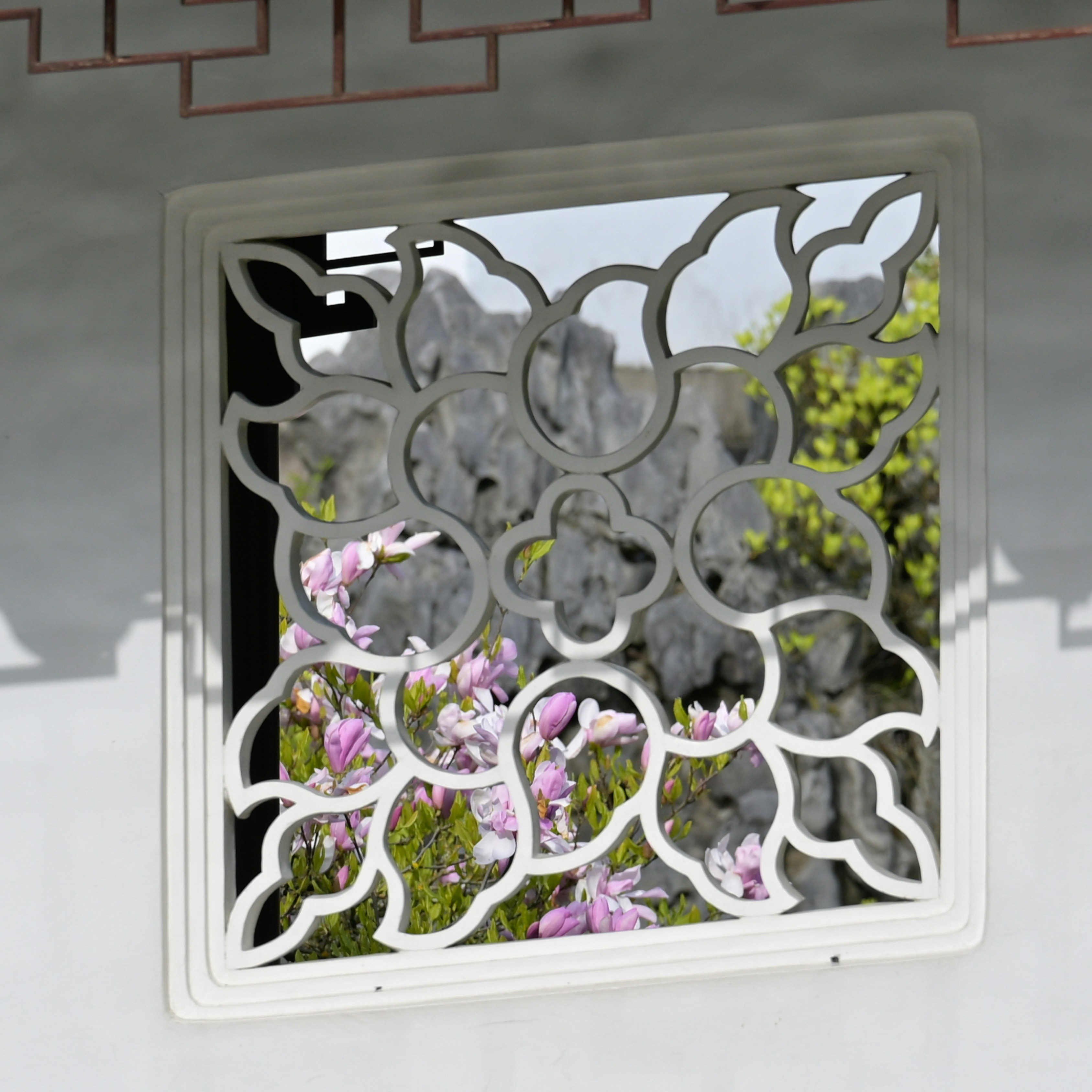 Geometric Lattice Window Framing Spring Blooms