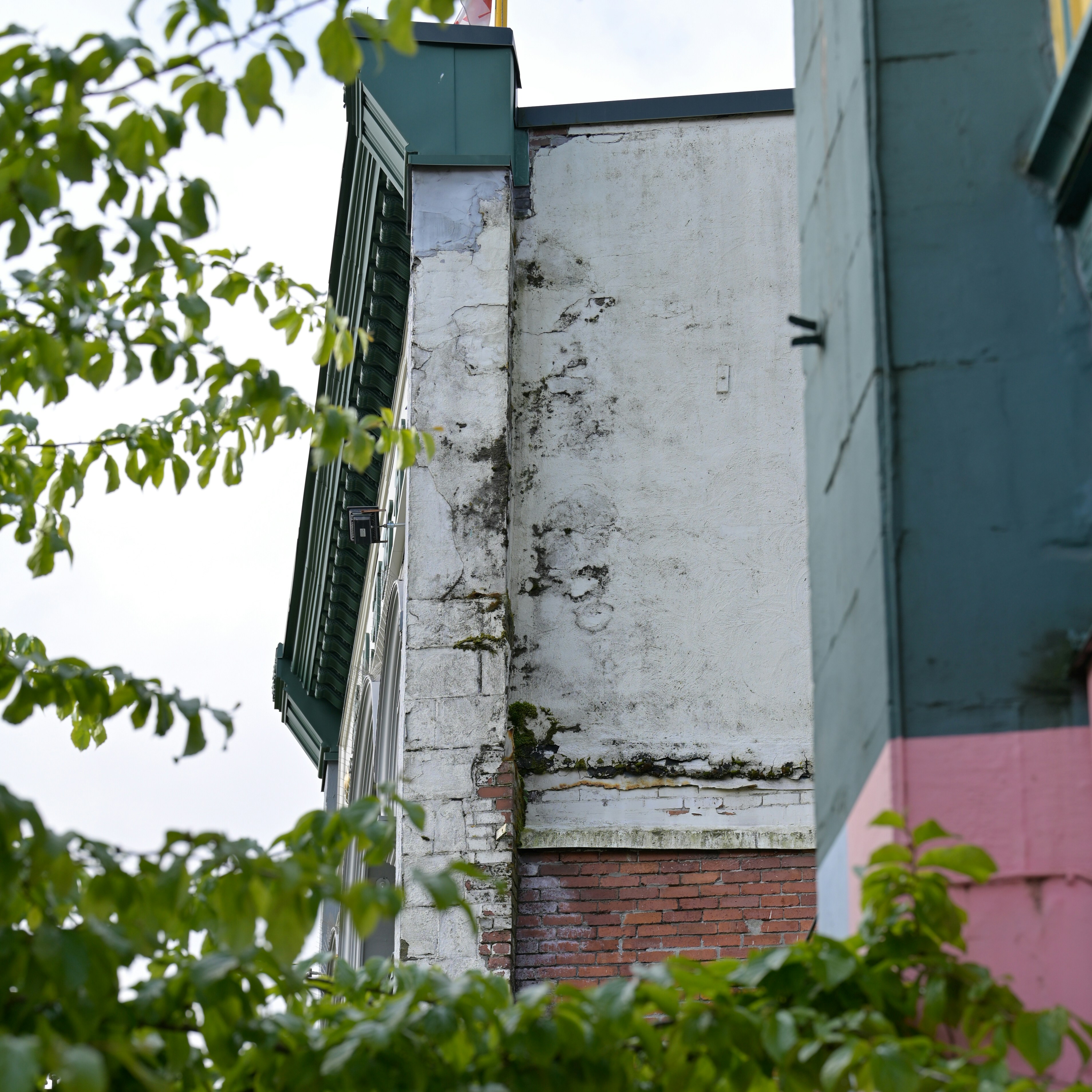 Turned Corner: Weathered Facade and Green Shutters