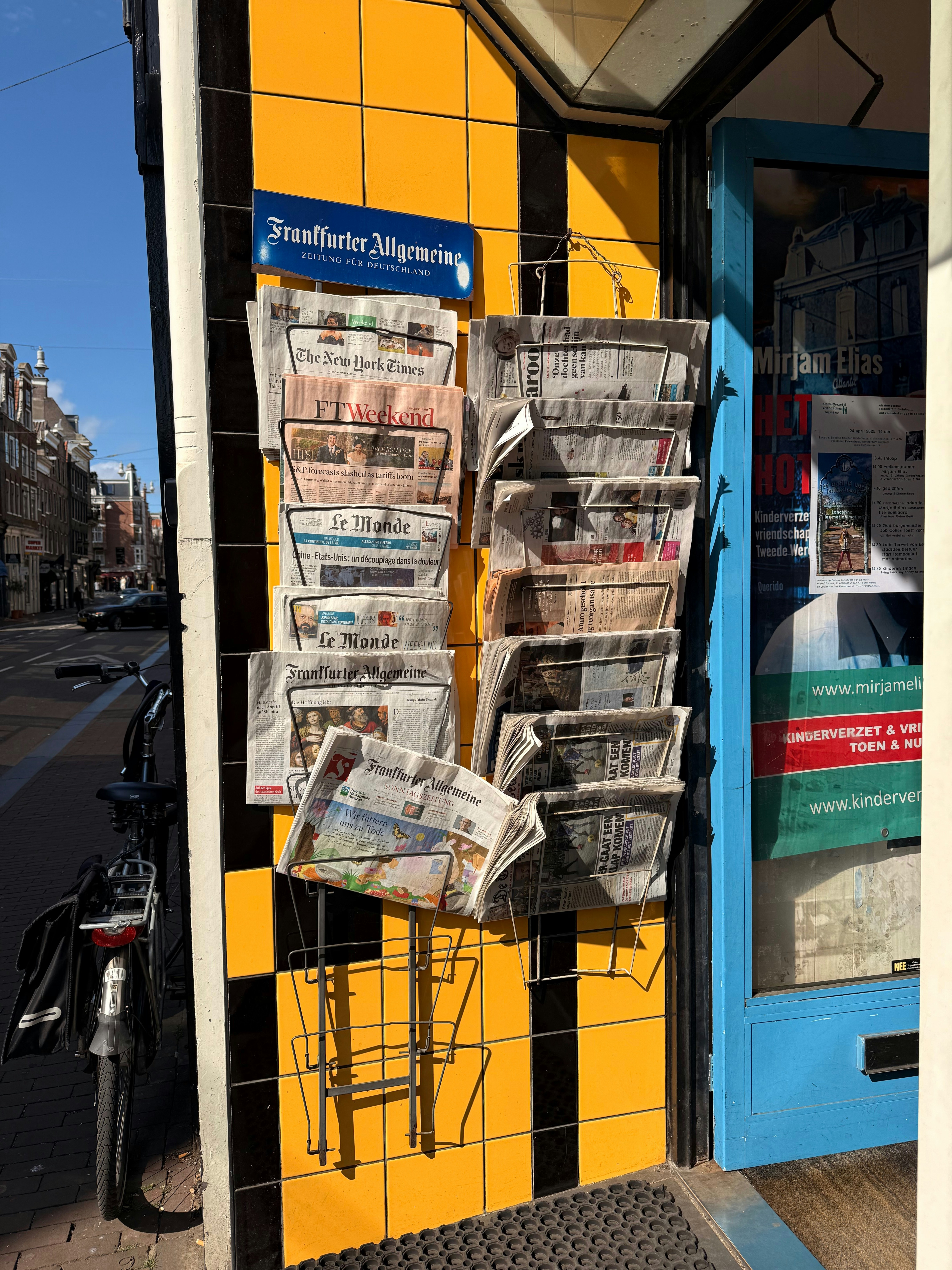 Newspapers are displayed outside a shop. photo – Free Human Image on ...