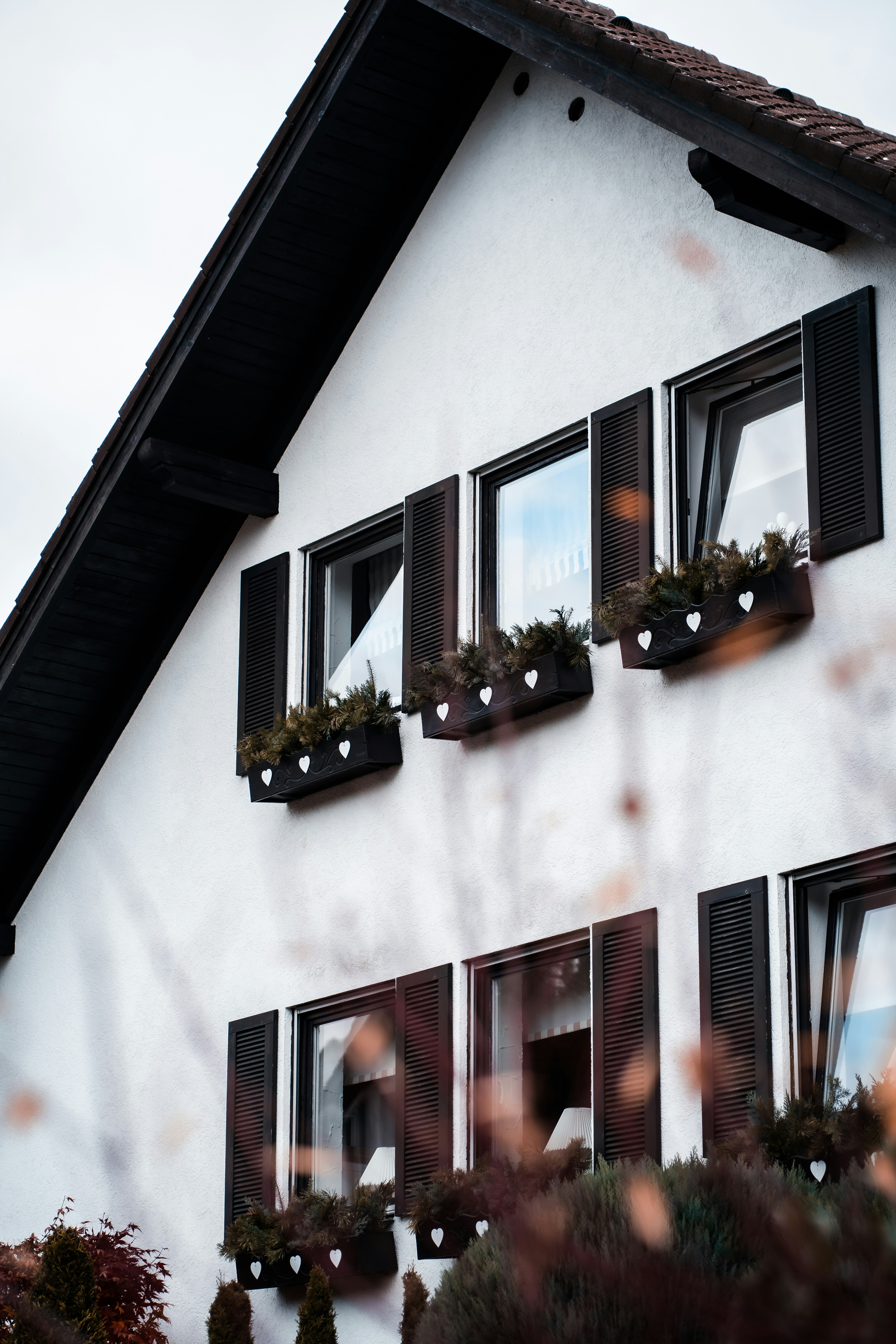 Chalet-Style Facade Framed by Heart-Adorned Planters