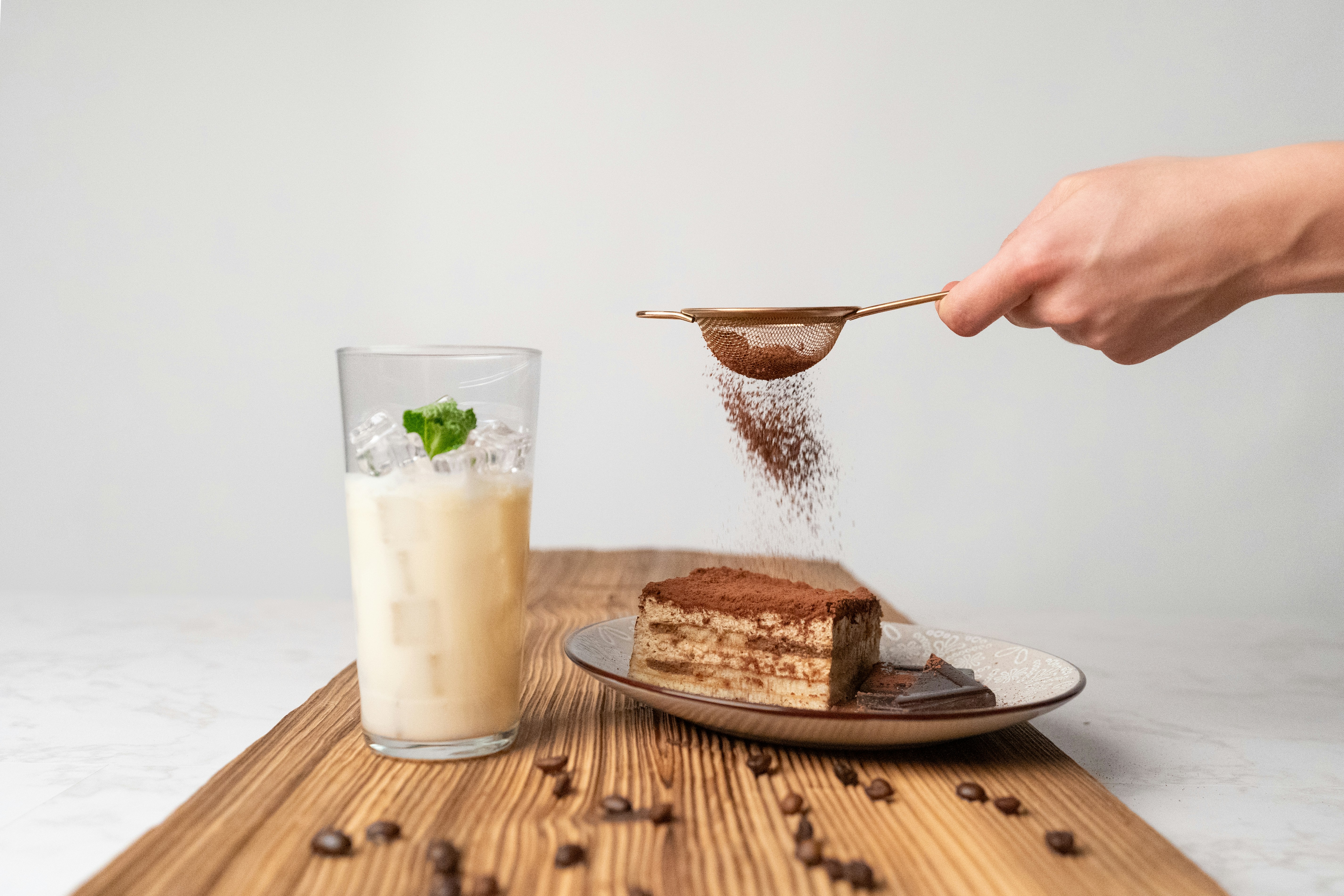 Someone dusting cocoa powder on tiramisu. photo – Free Ice Image on ...