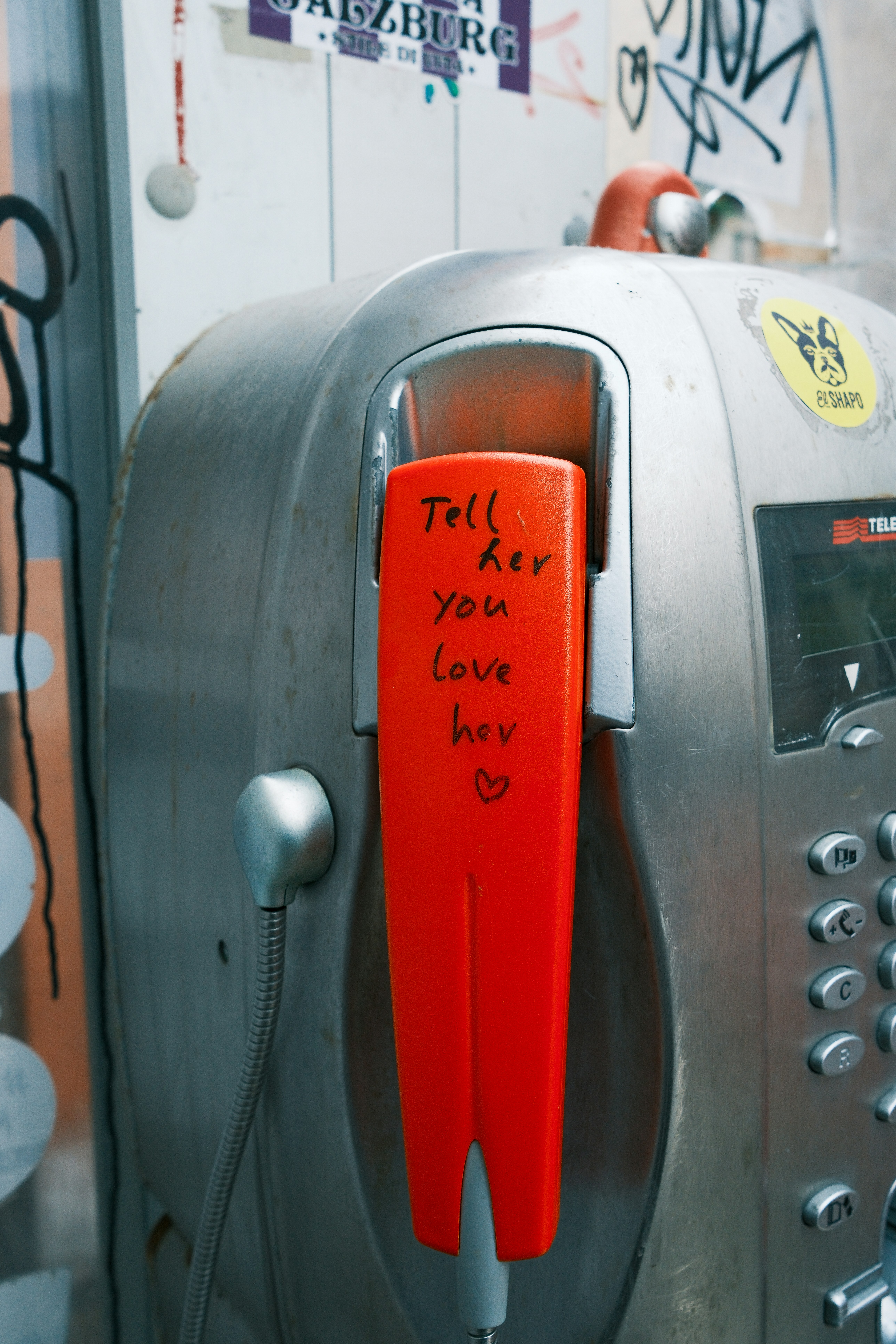 The Red Confession on a Graffiti Payphone