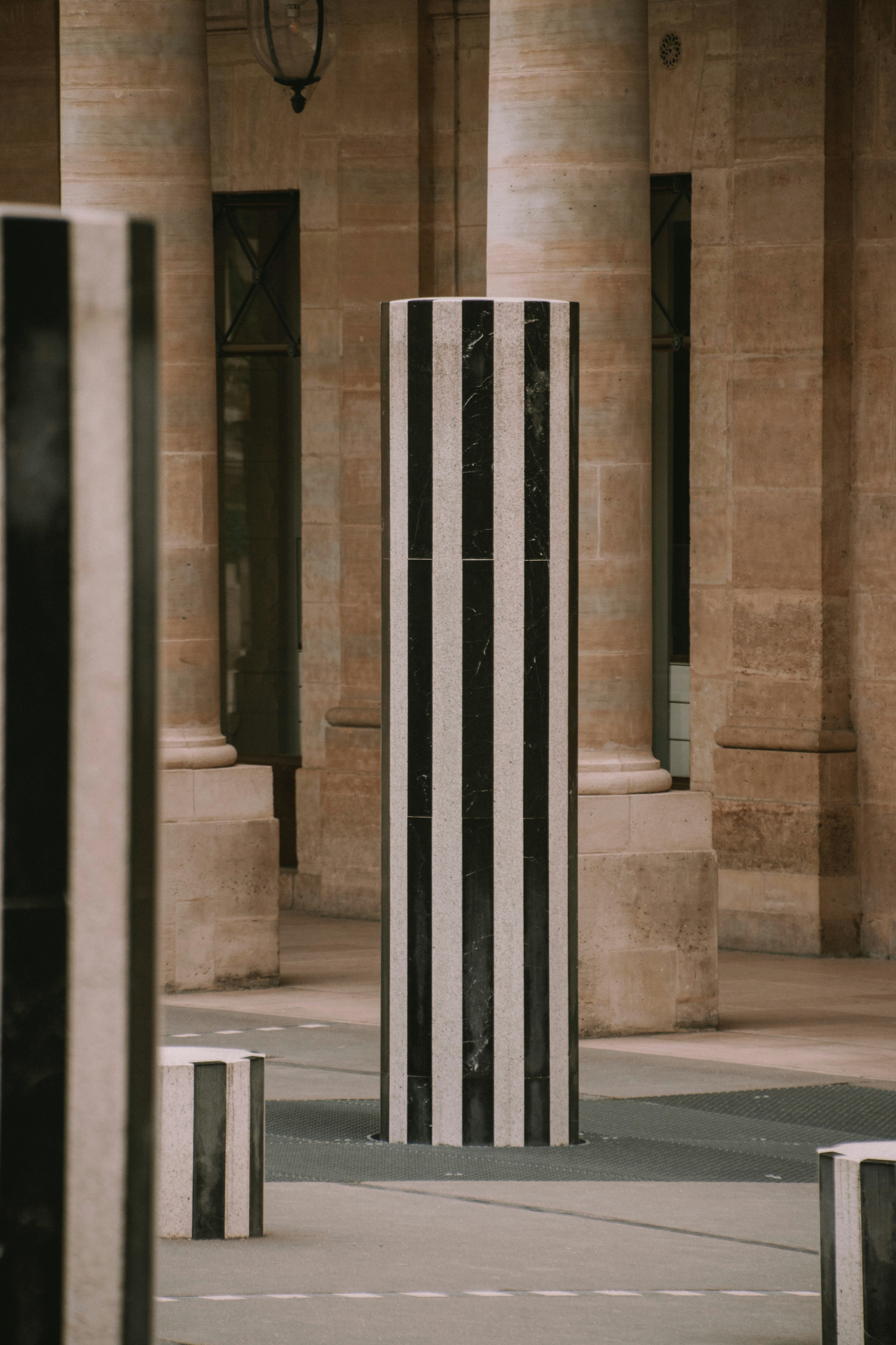 Black and white striped pillars stand in a stone structure. photo ...