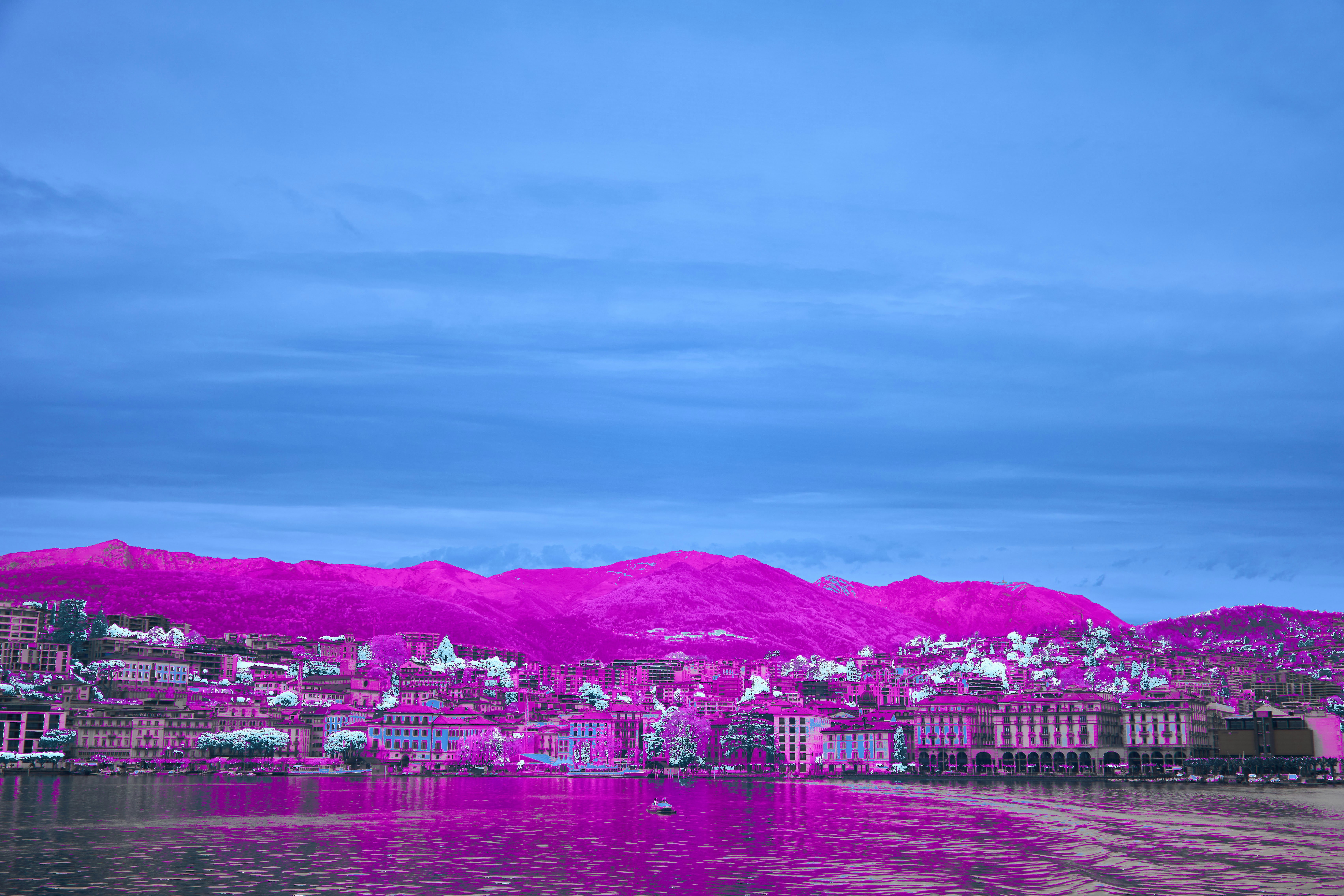 The city and mountains are pink and blue.