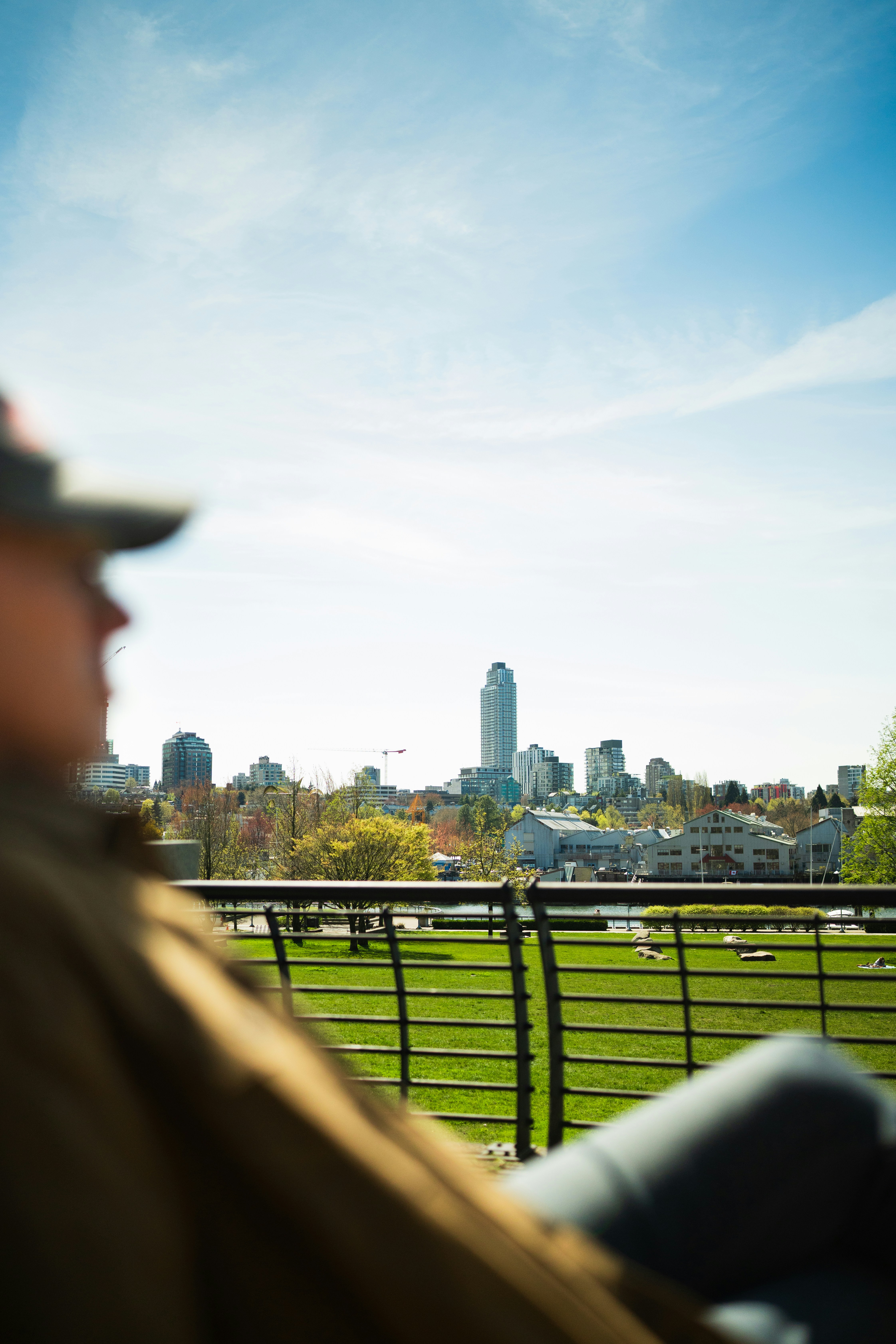 Blurred Foreground, Bold Skyline: A Quiet Balcony Over a Growing City