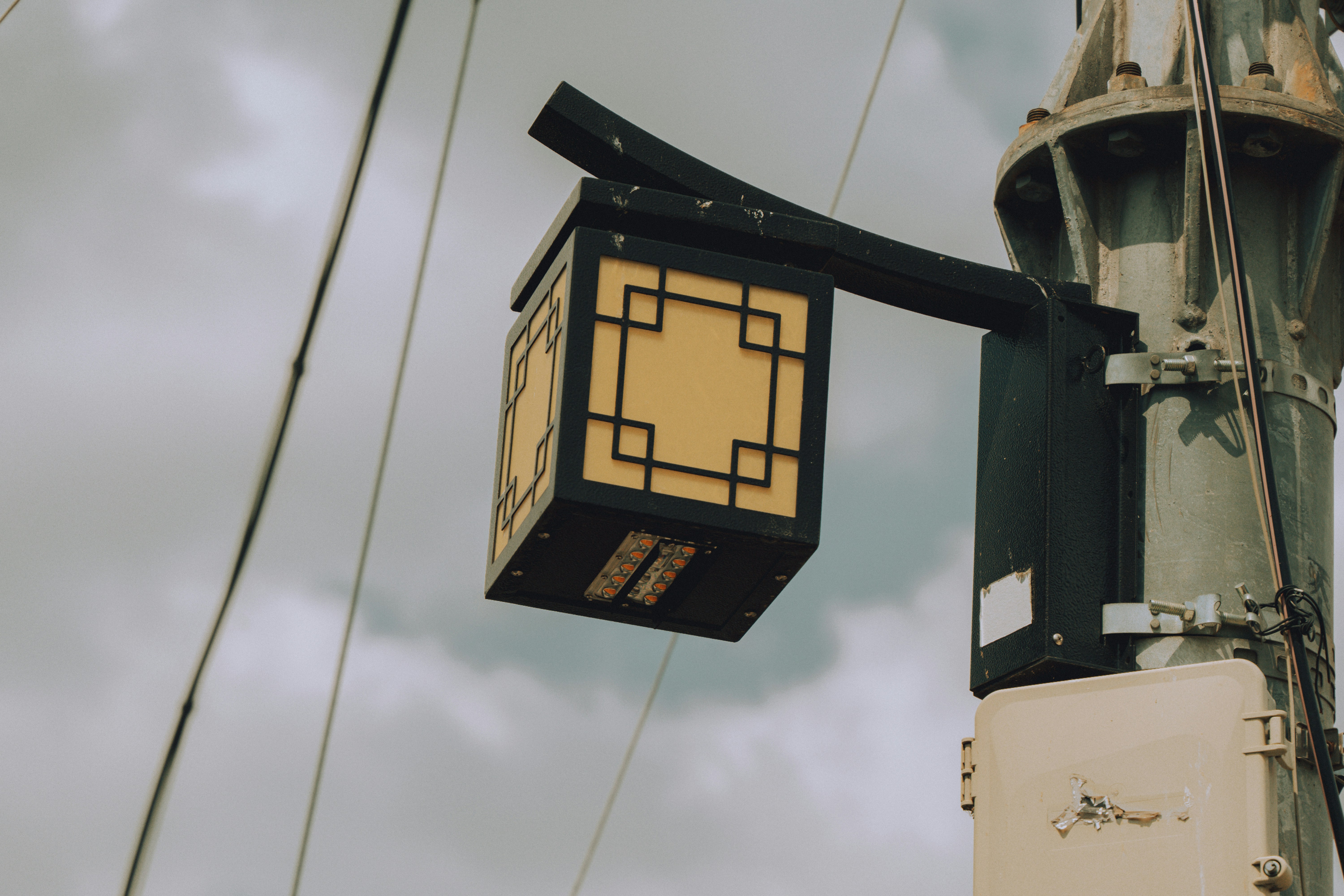 Geometric Lantern on a Weathered Streetlight