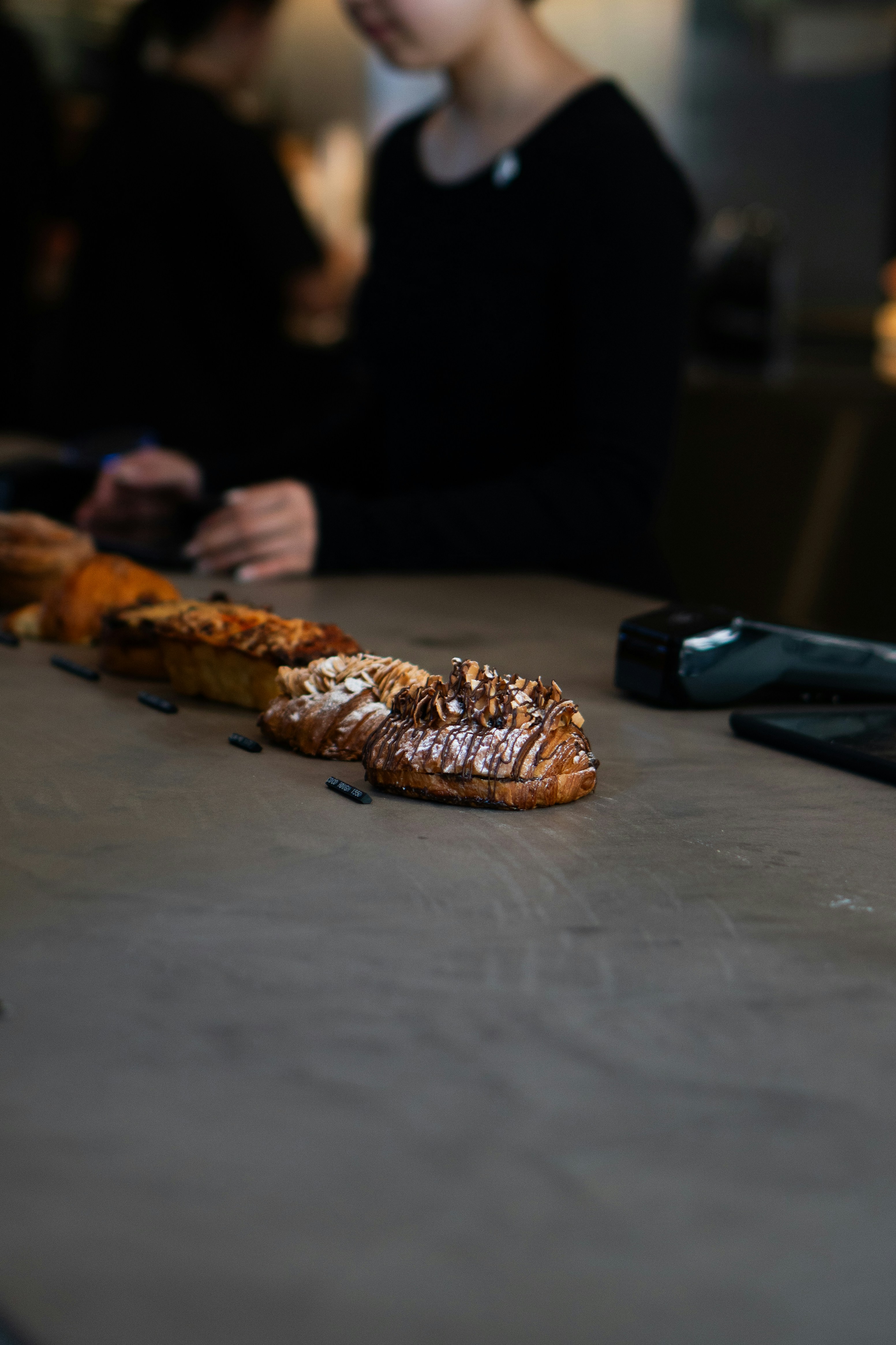 Caramel-Topped Pastries Line Up on a Quiet Café Counter