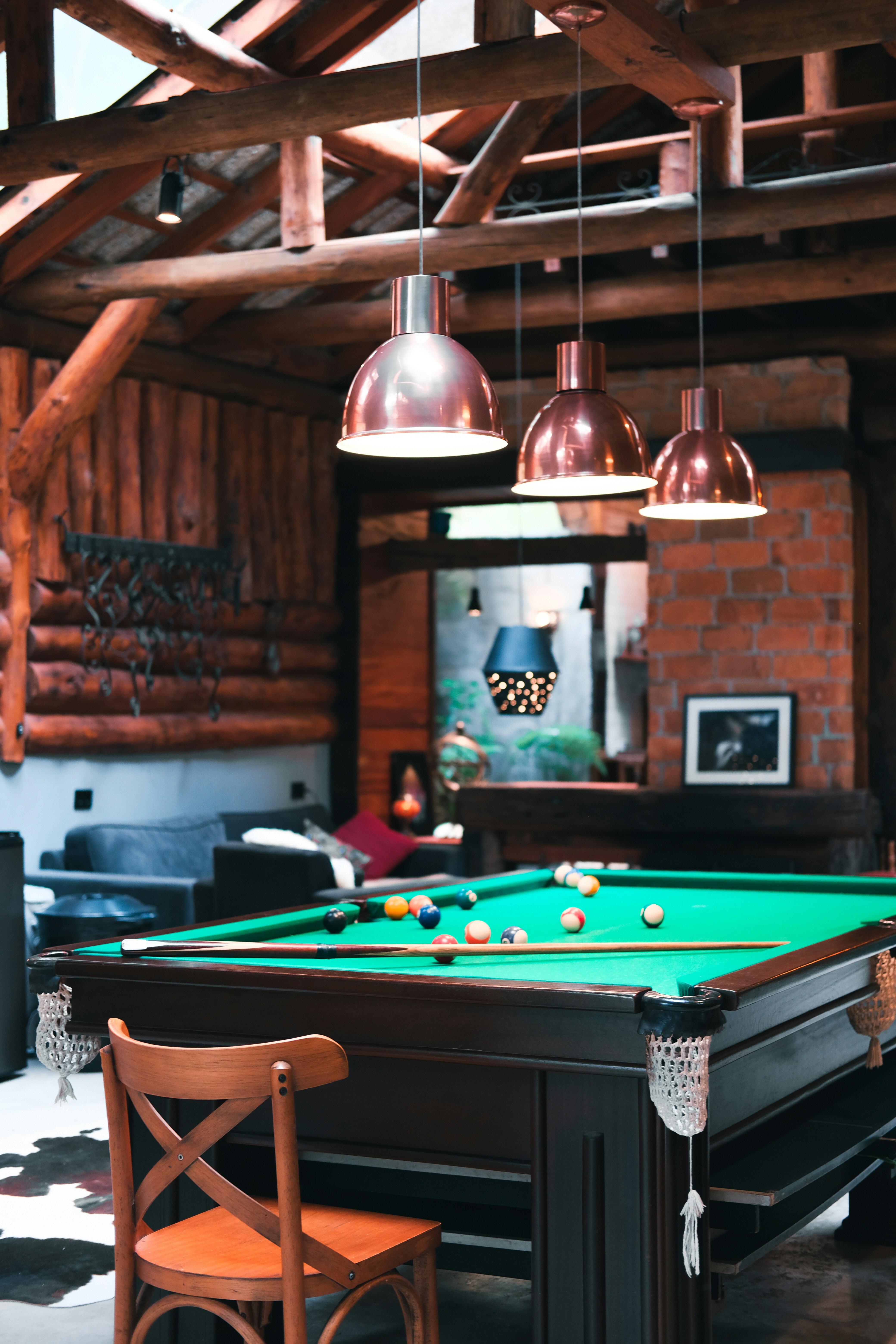 Copper Lamps Over a Rustic Loft Pool Room