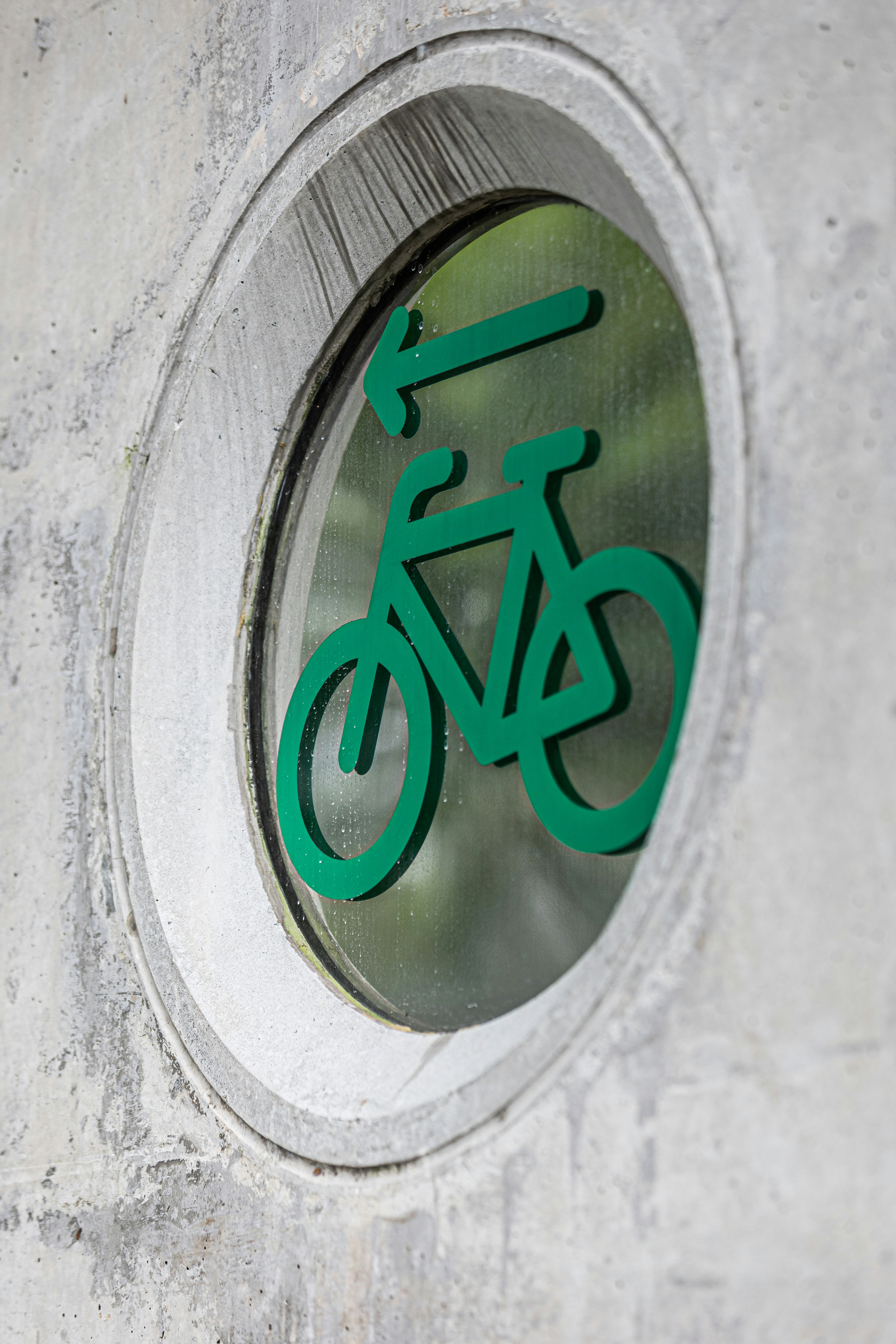 Oasis of Green in Grey: Circular Bicycle Sign in Concrete