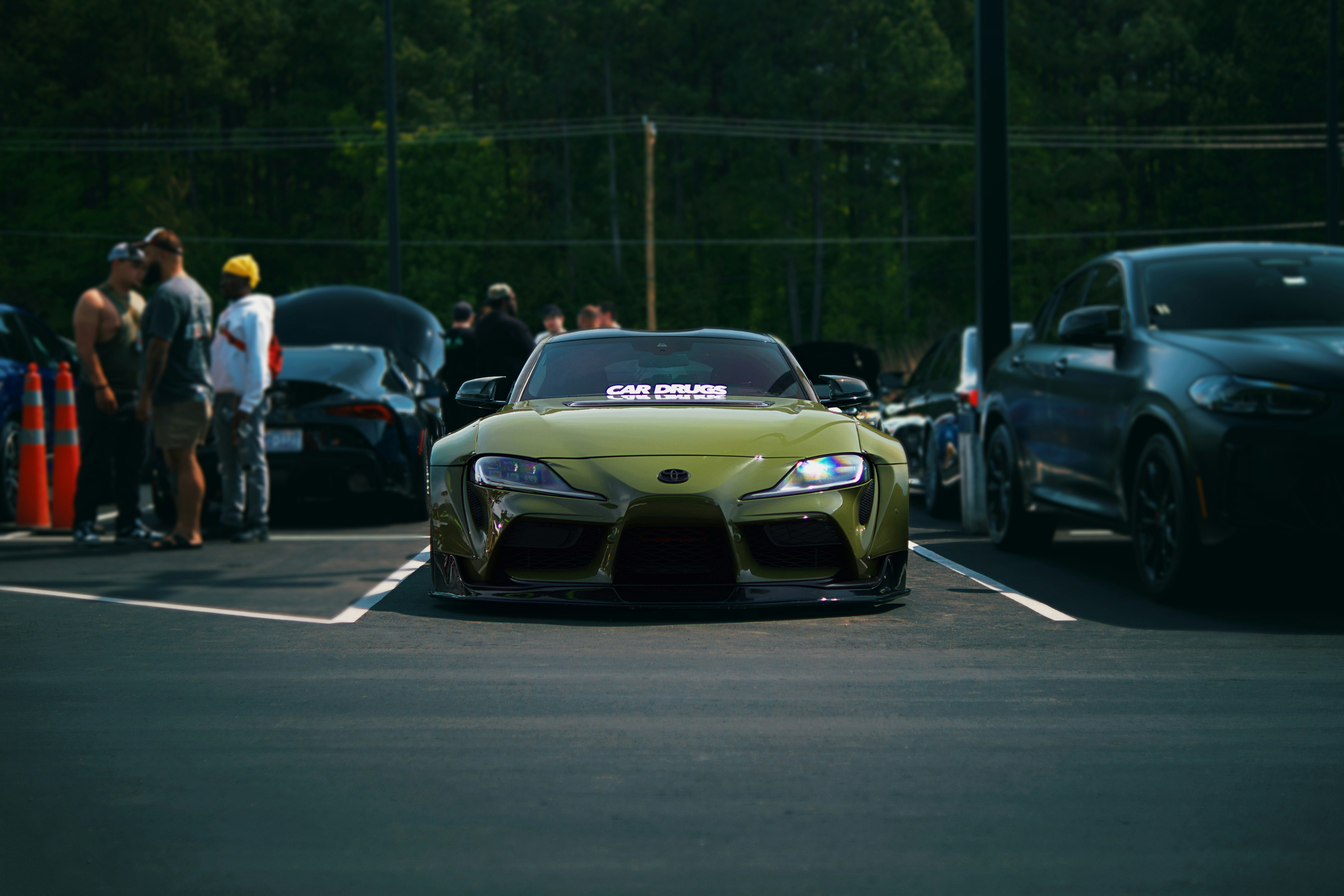 A green sports car sits in a parking lot. photo – Free Usa Image on ...