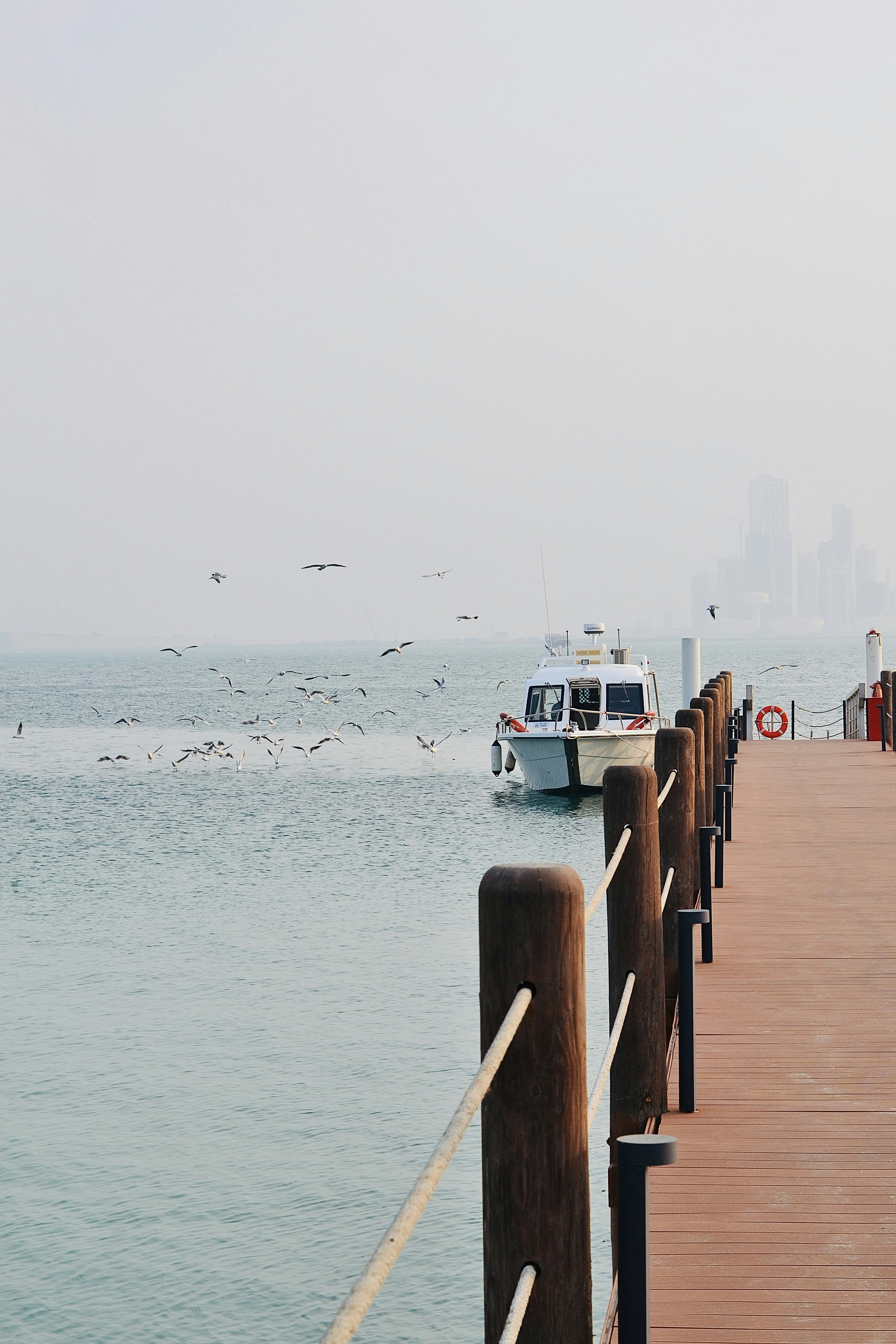 Pier Toward the Mist: A Harbor Stretch Toward a Distant Skyline