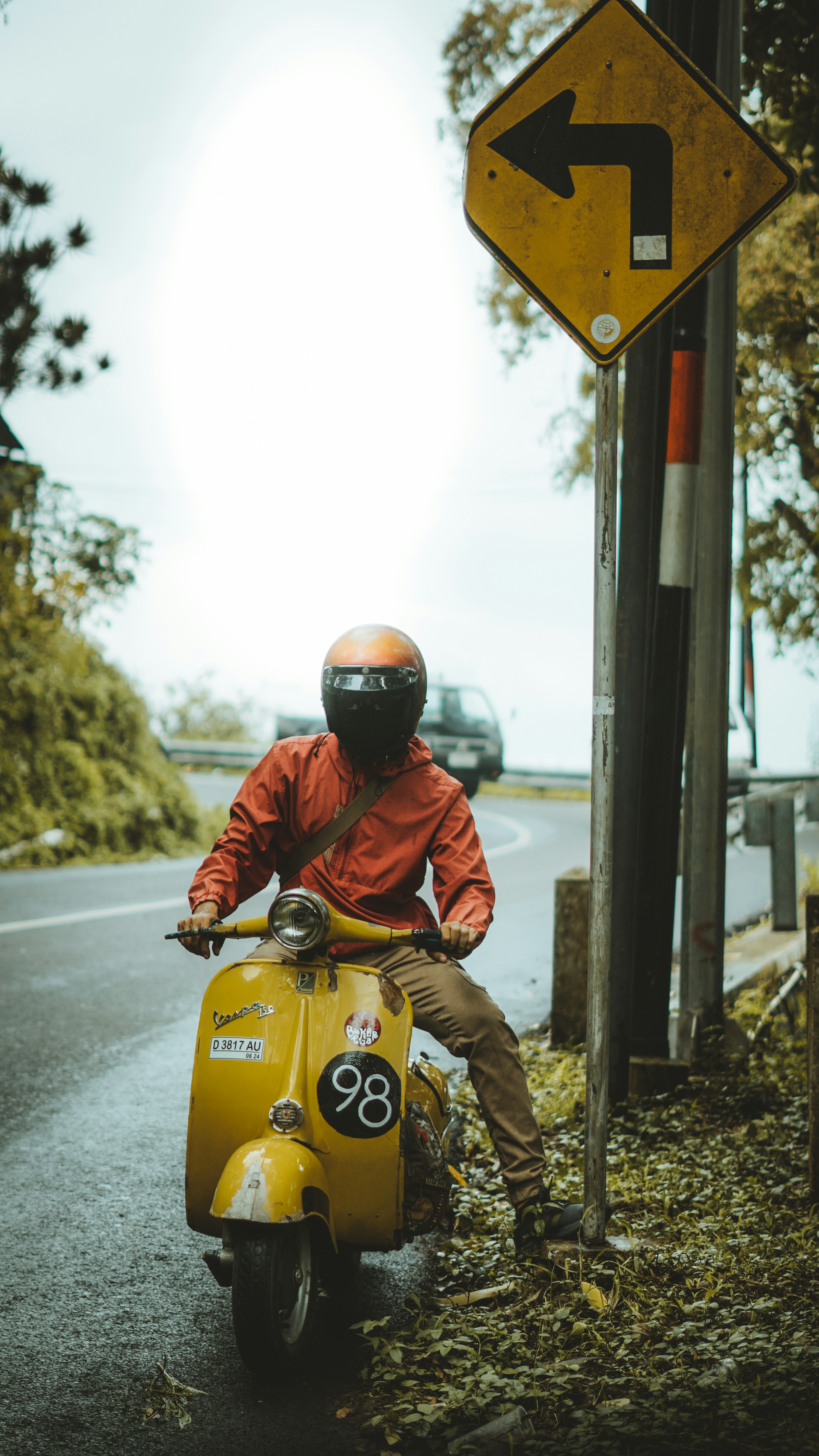Hairpin Moment: A Yellow Vespa at the Bend