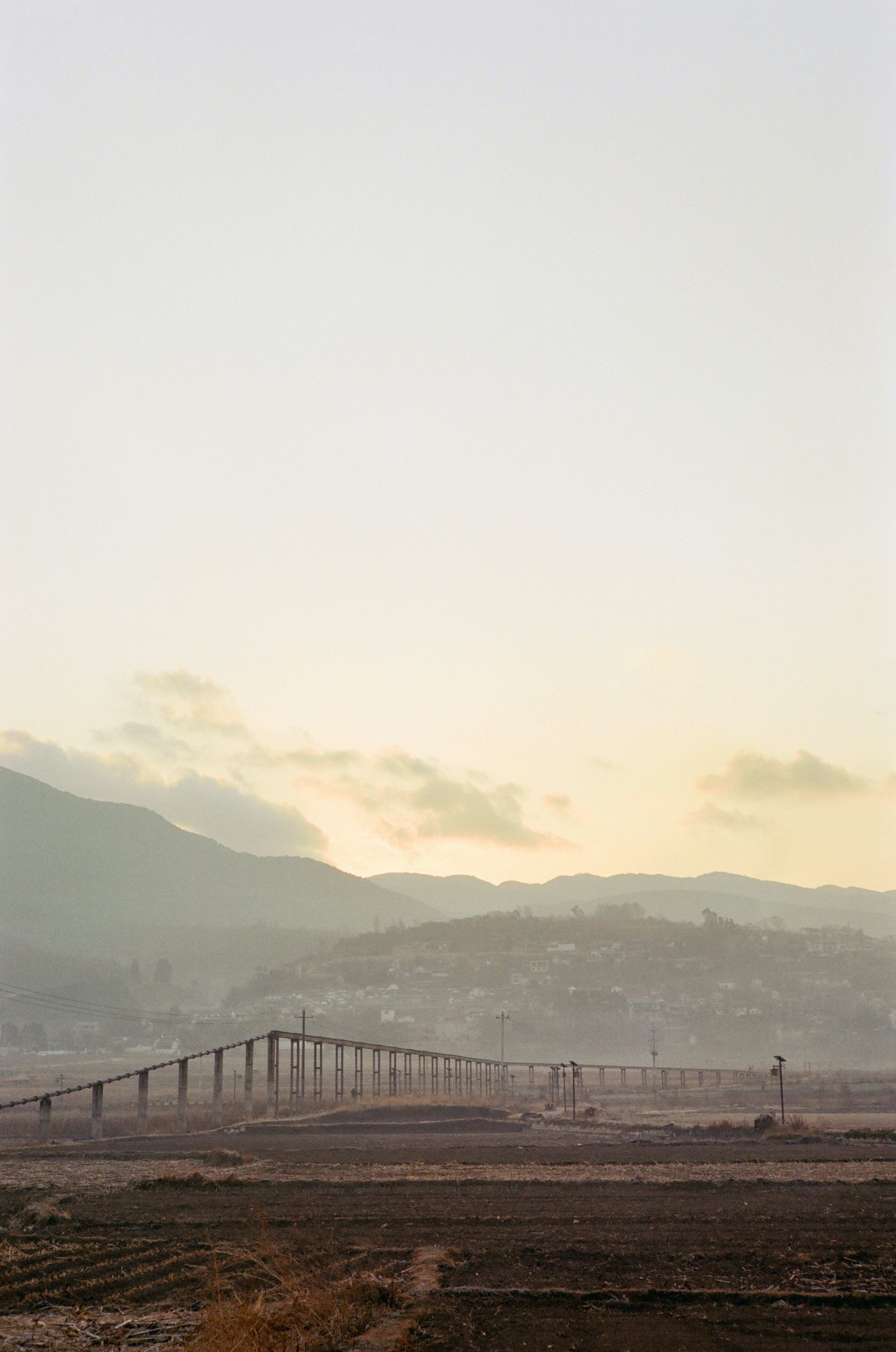 A long bridge stretches across a dusky landscape. photo – Free China ...