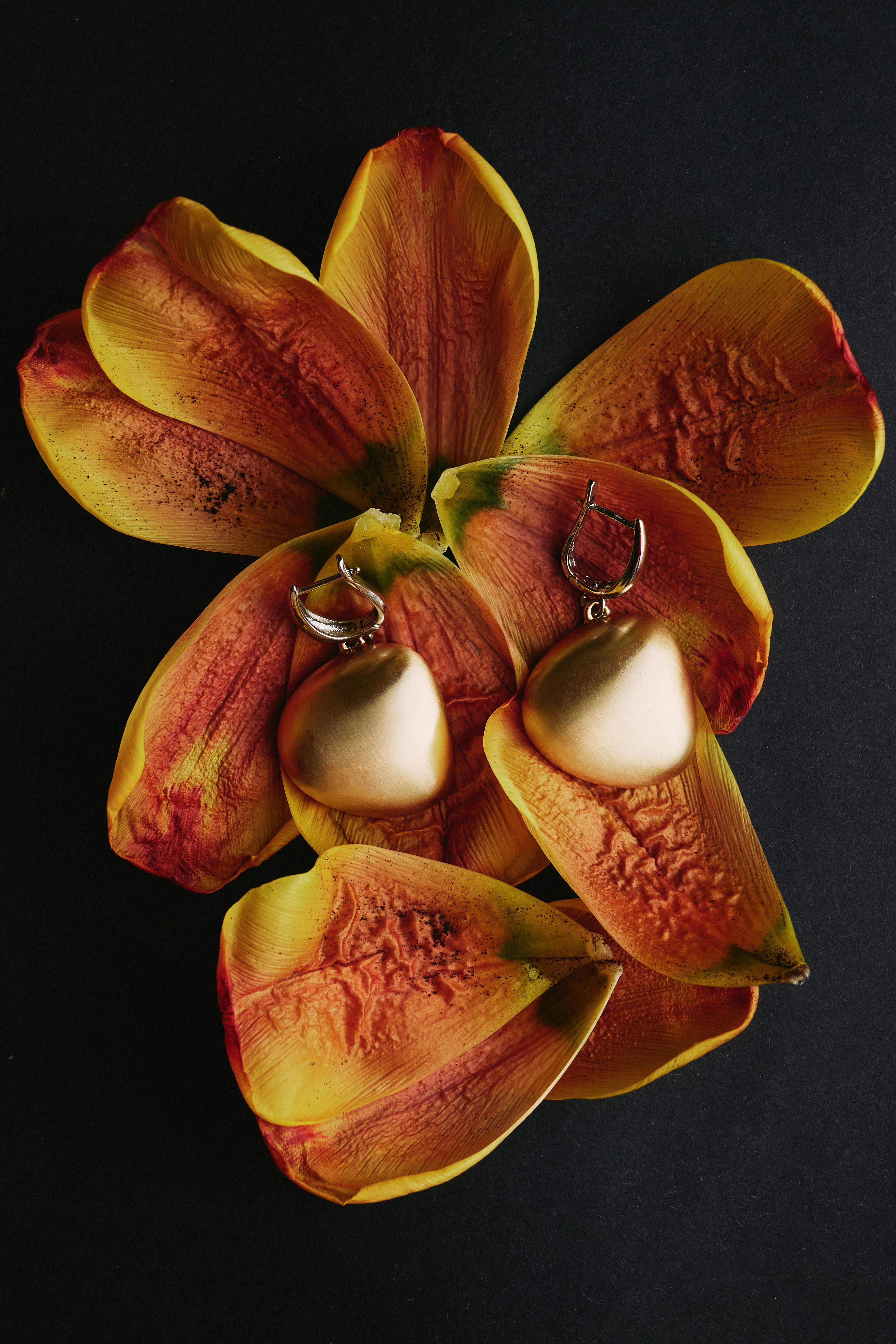 Ember-Orange Petals Hold Pearl Drops: A Floral Jewelry Still Life