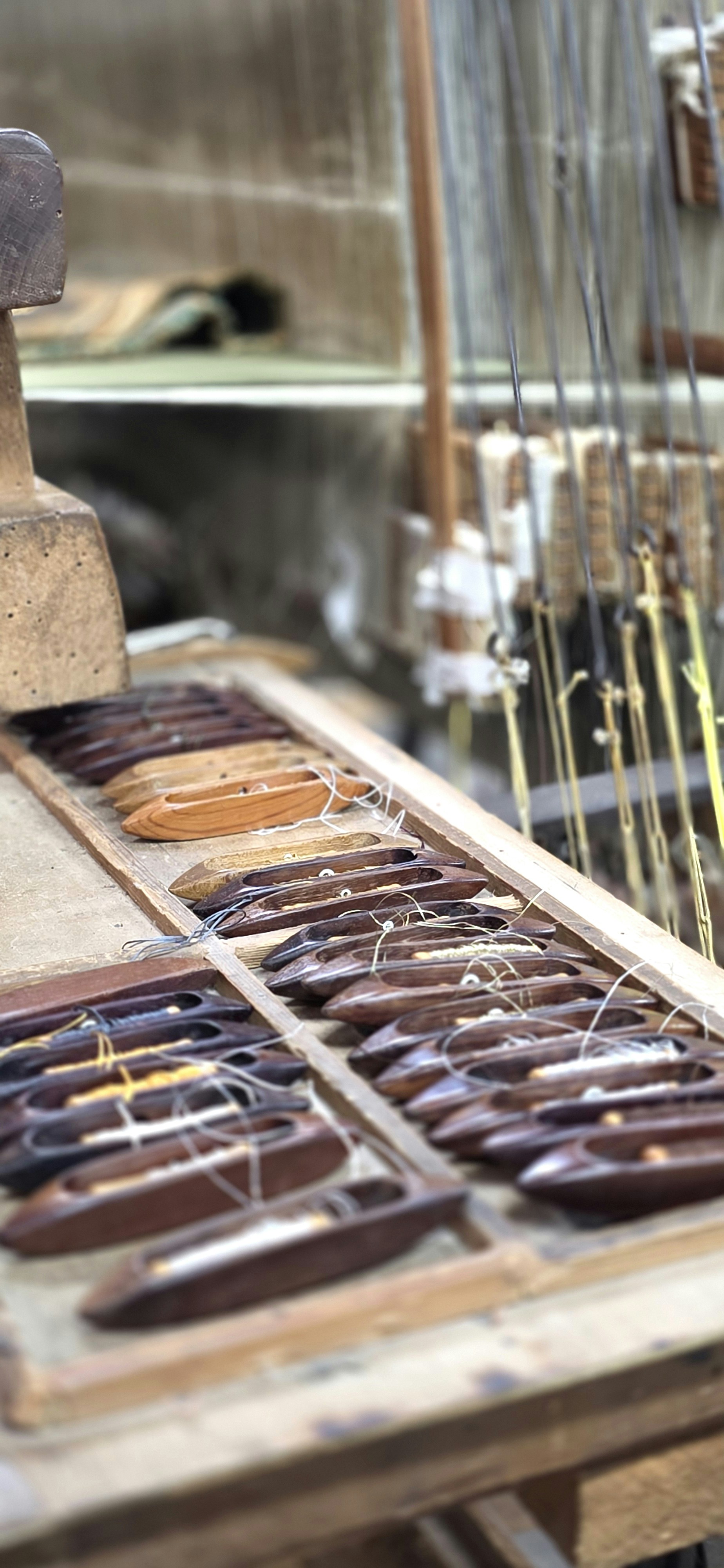 Strings of Time: A Row of Sunglasses Waiting for the Loom to Stop