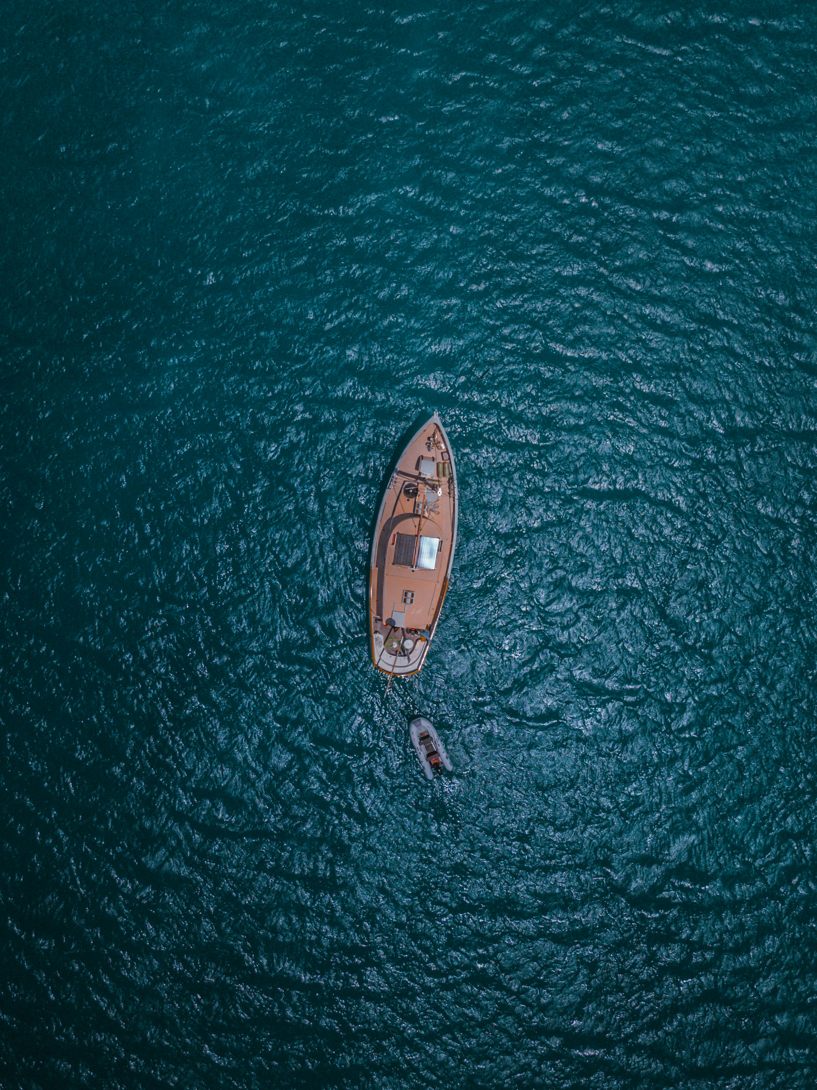 A lone boat navigates the tranquil waters, surrounded by deep blue hues, evoking a sense of peace and solitude.