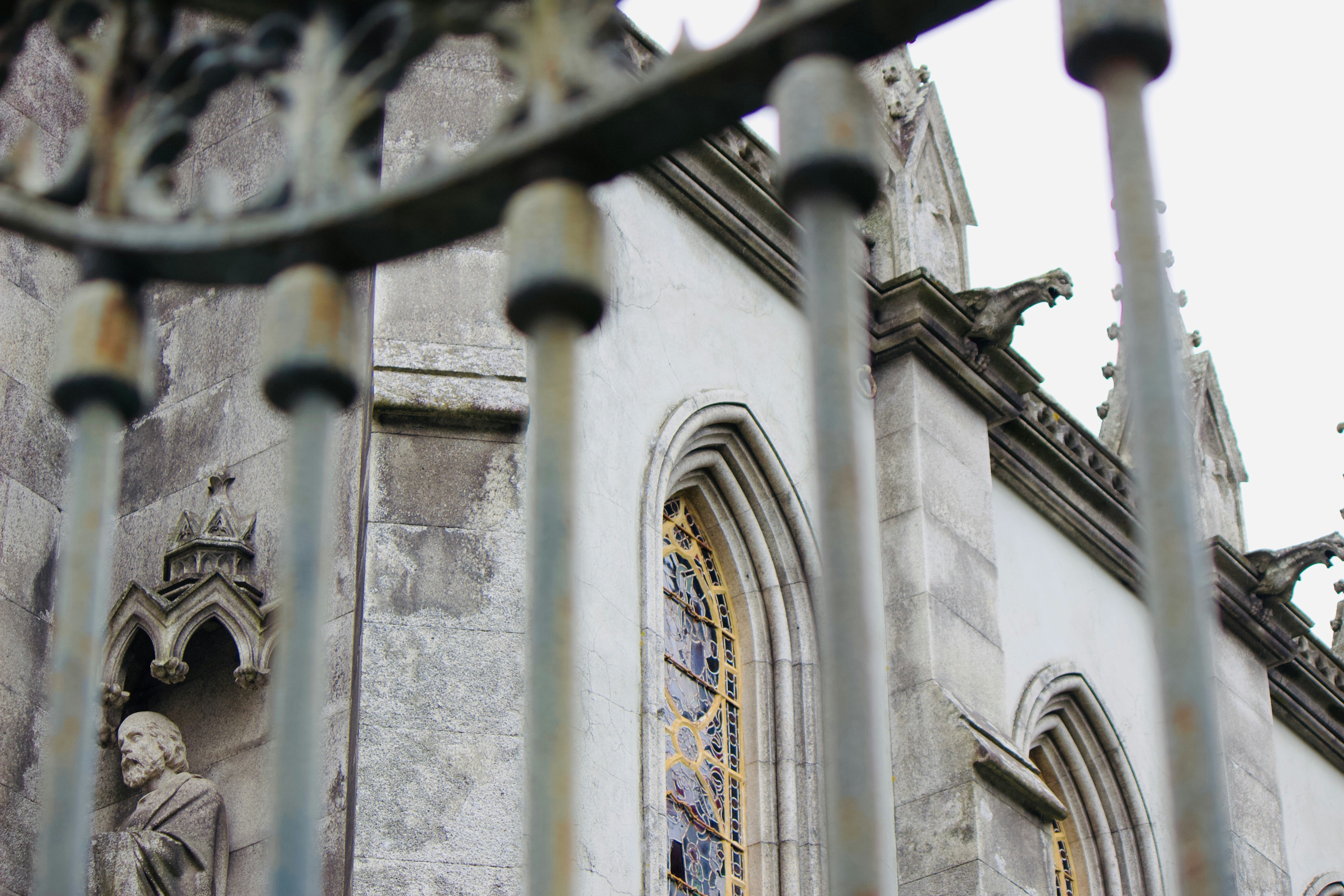 Gilded Gothic Window Framed by Weathered Iron