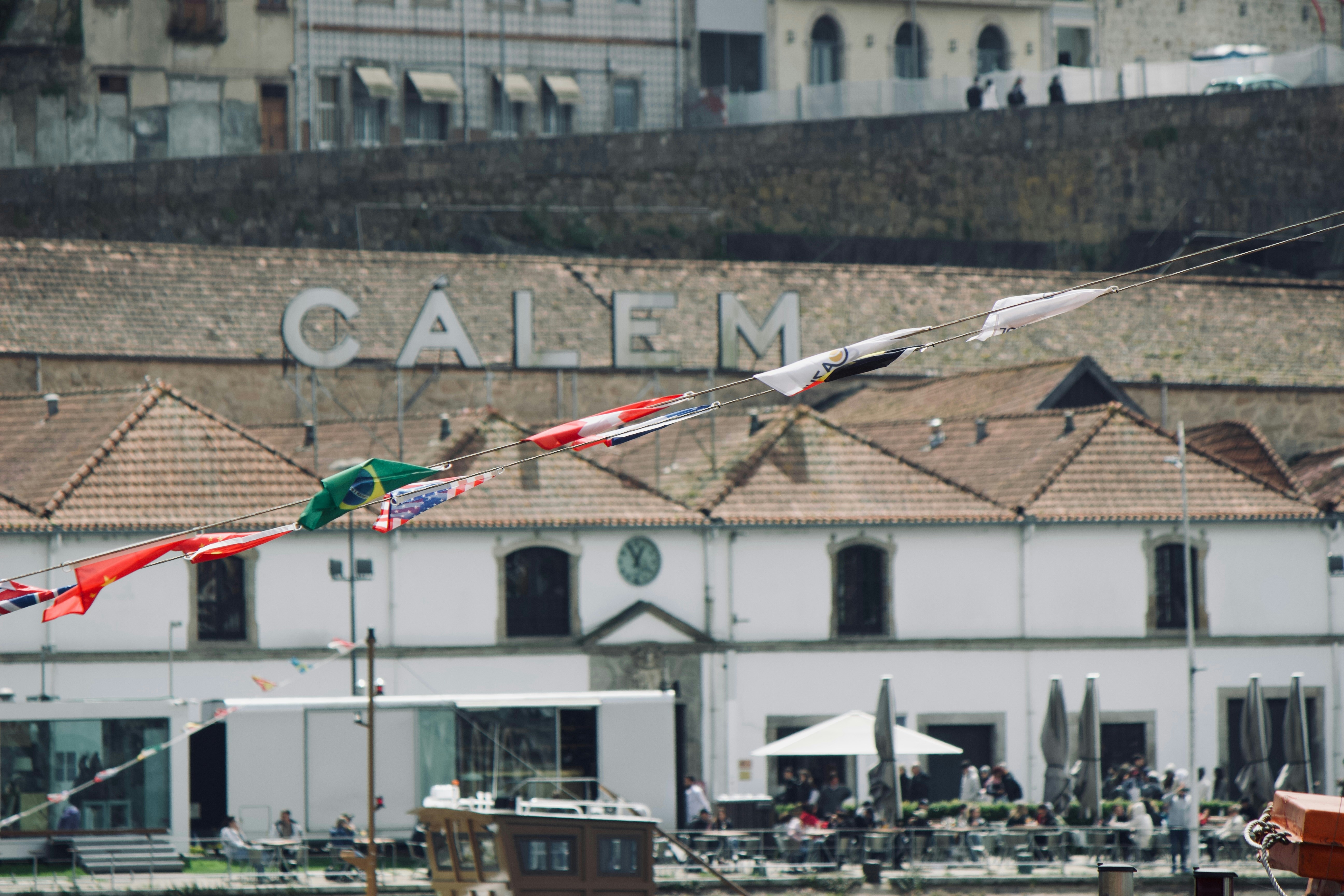 Colorful kites over a historic waterfront cafe
