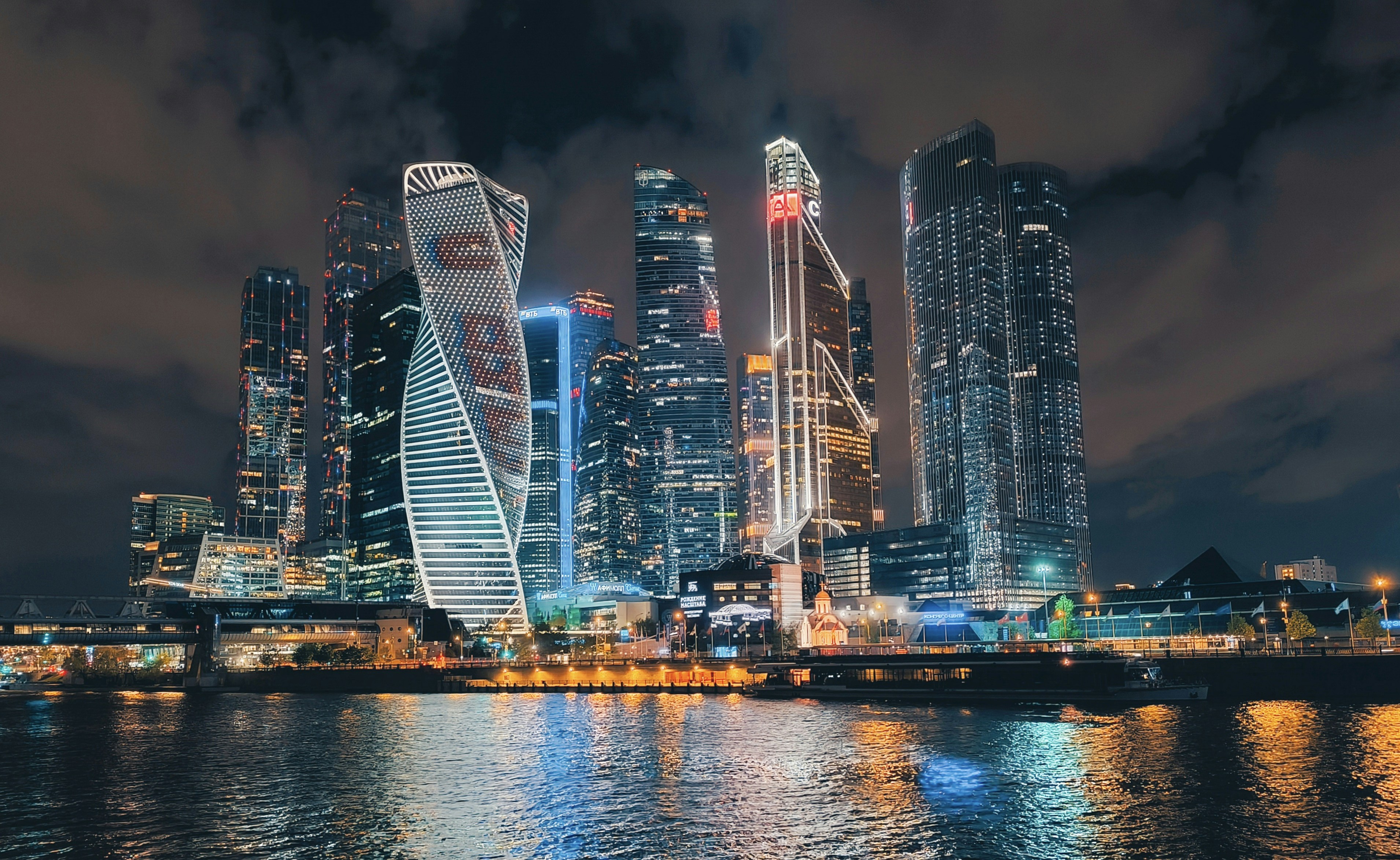 Neon Canopy Over the River: Nightscape of Glowing Skyscrapers
