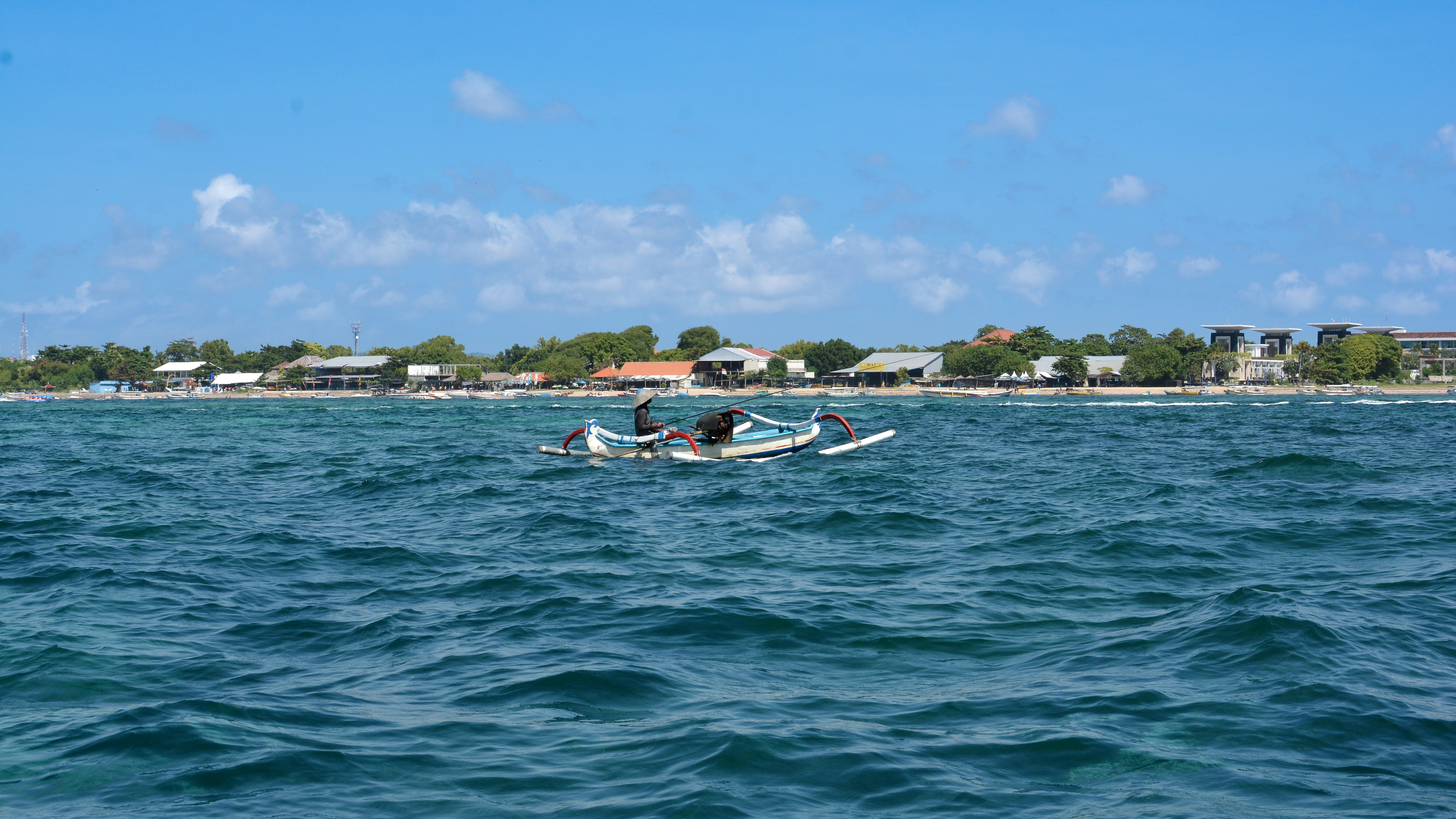 Boats sail on the blue sea near a distant coast. photo – Free Indonesia ...