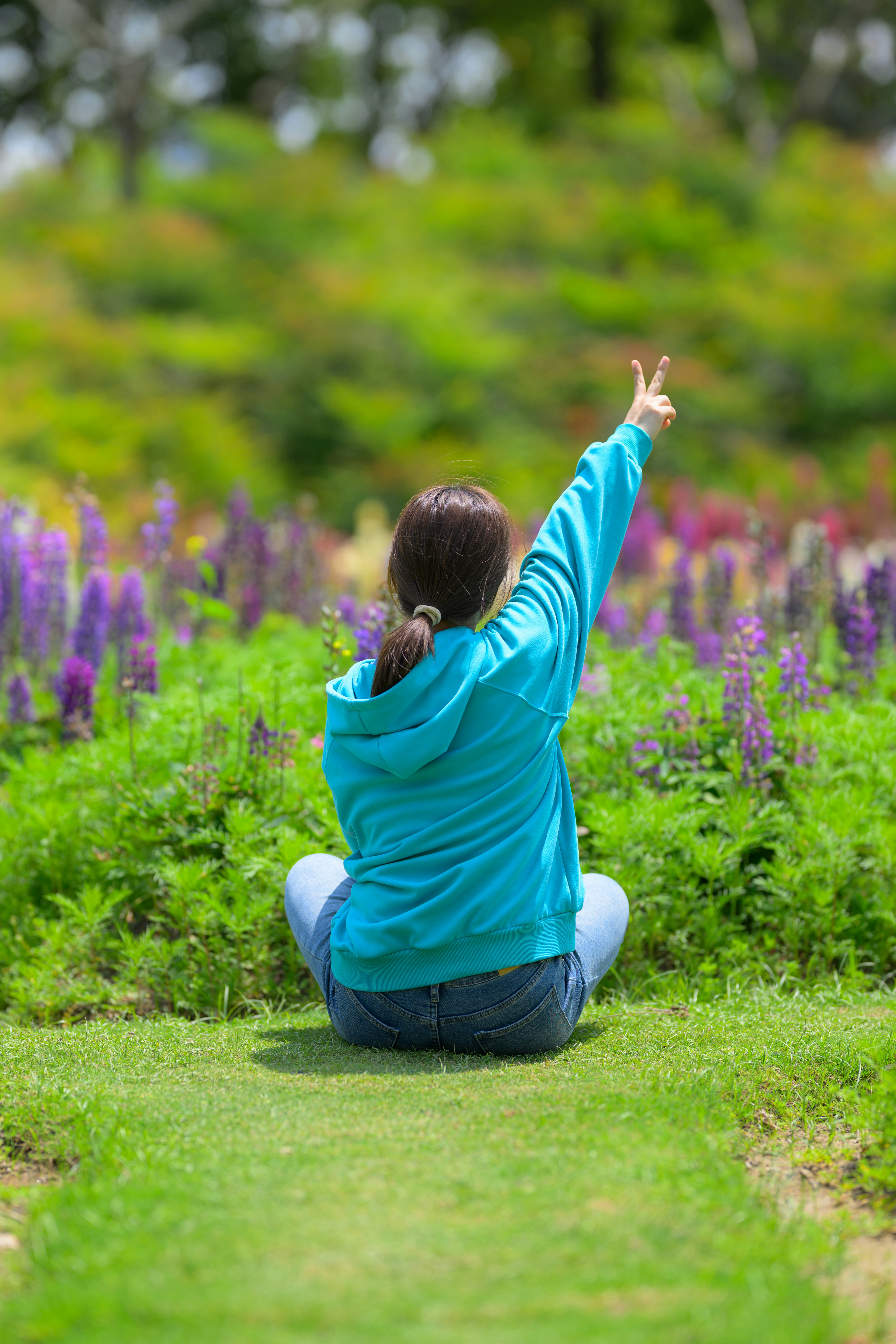 Victory in Bloom: A girl raises a peaceful salute amid a field of lavender