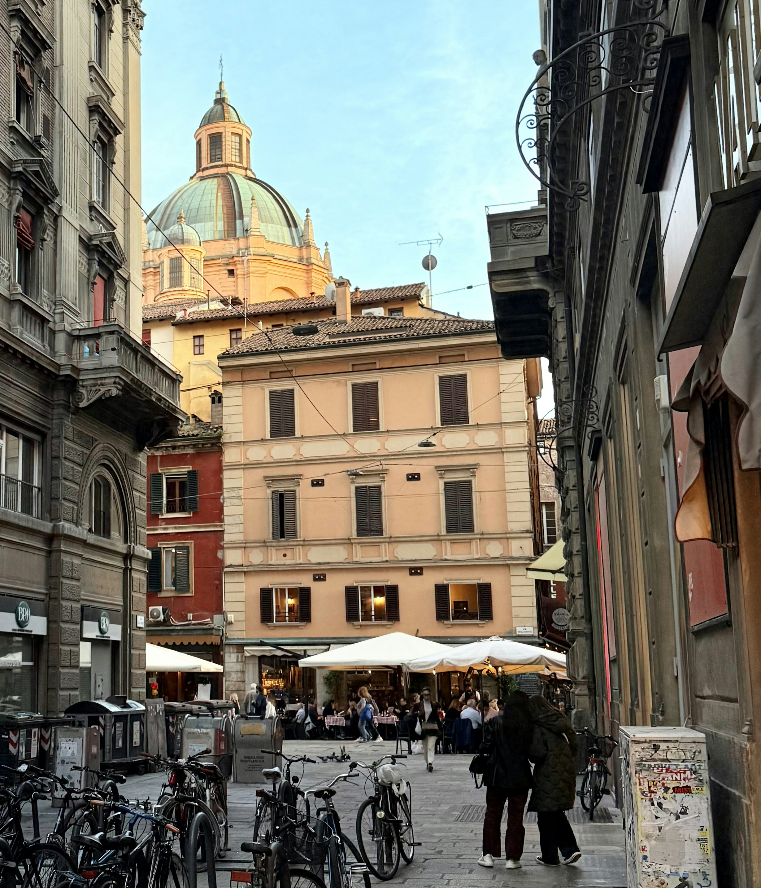 Piazza in Focus: Dome Towers Over a Sunlit Street Café