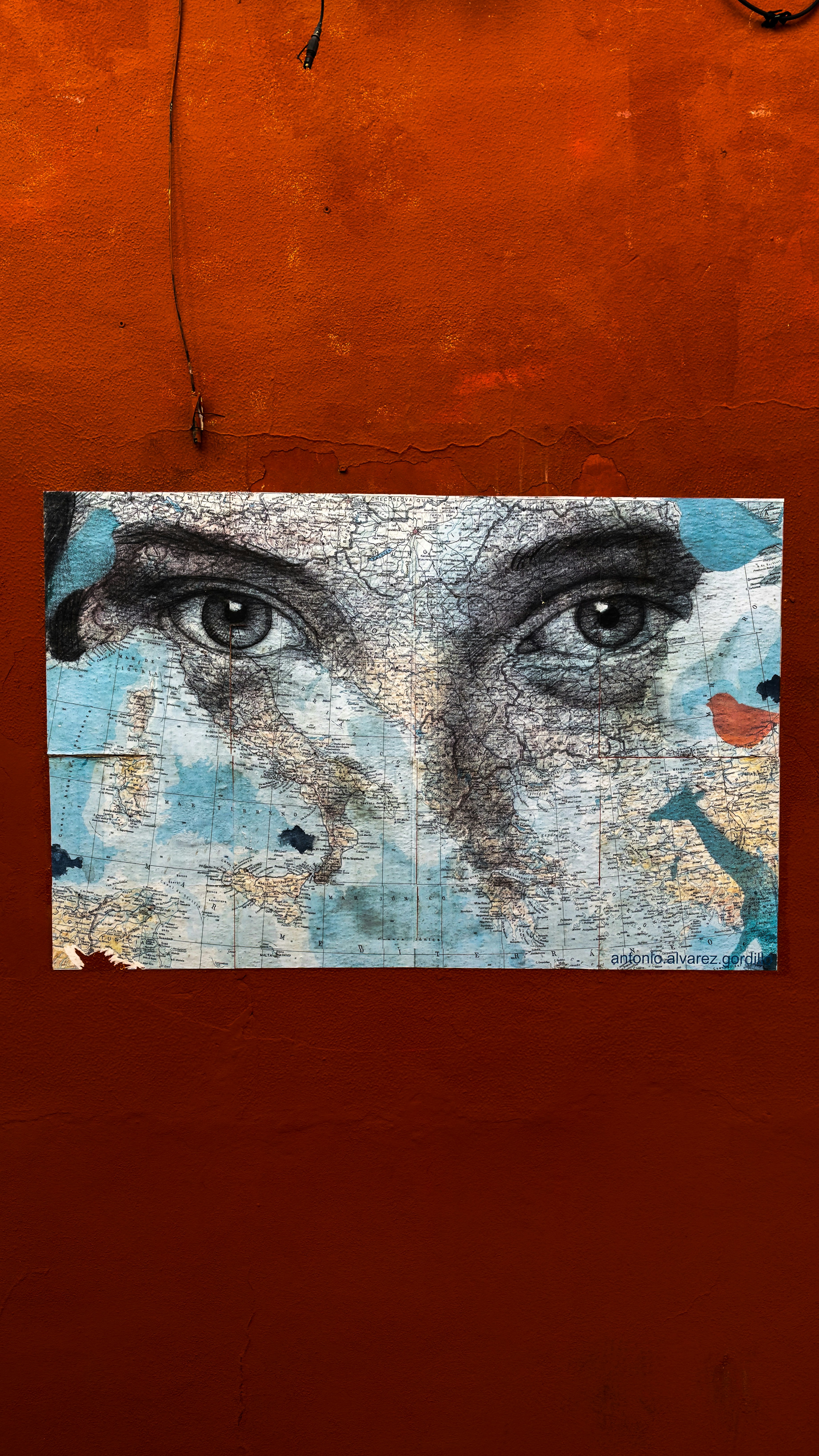 Eyes of a Wall: A Street Portrait Adrift on Orange Brick