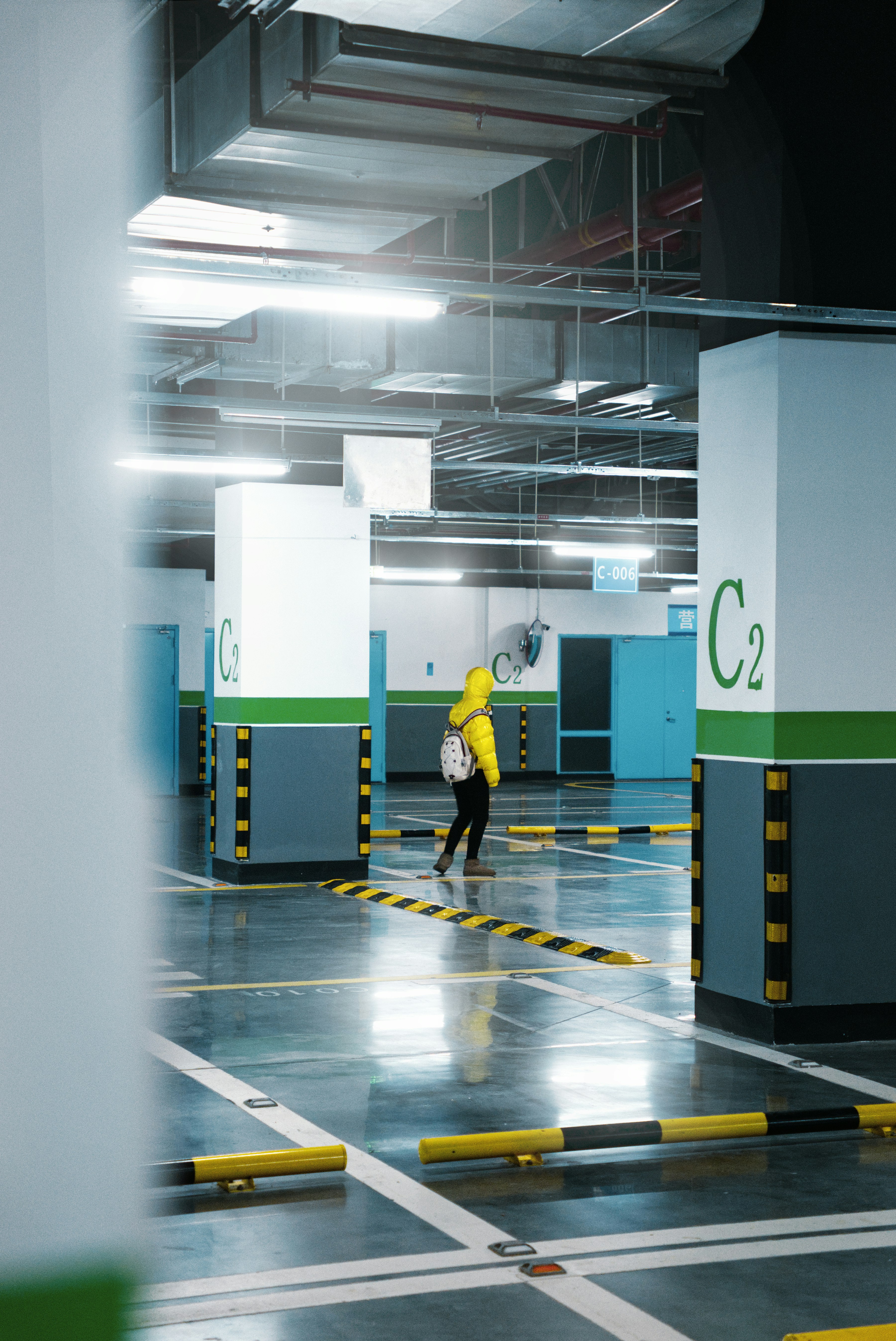 Yellow-Clad Wanderer in a Neon-Lit Parking Garage