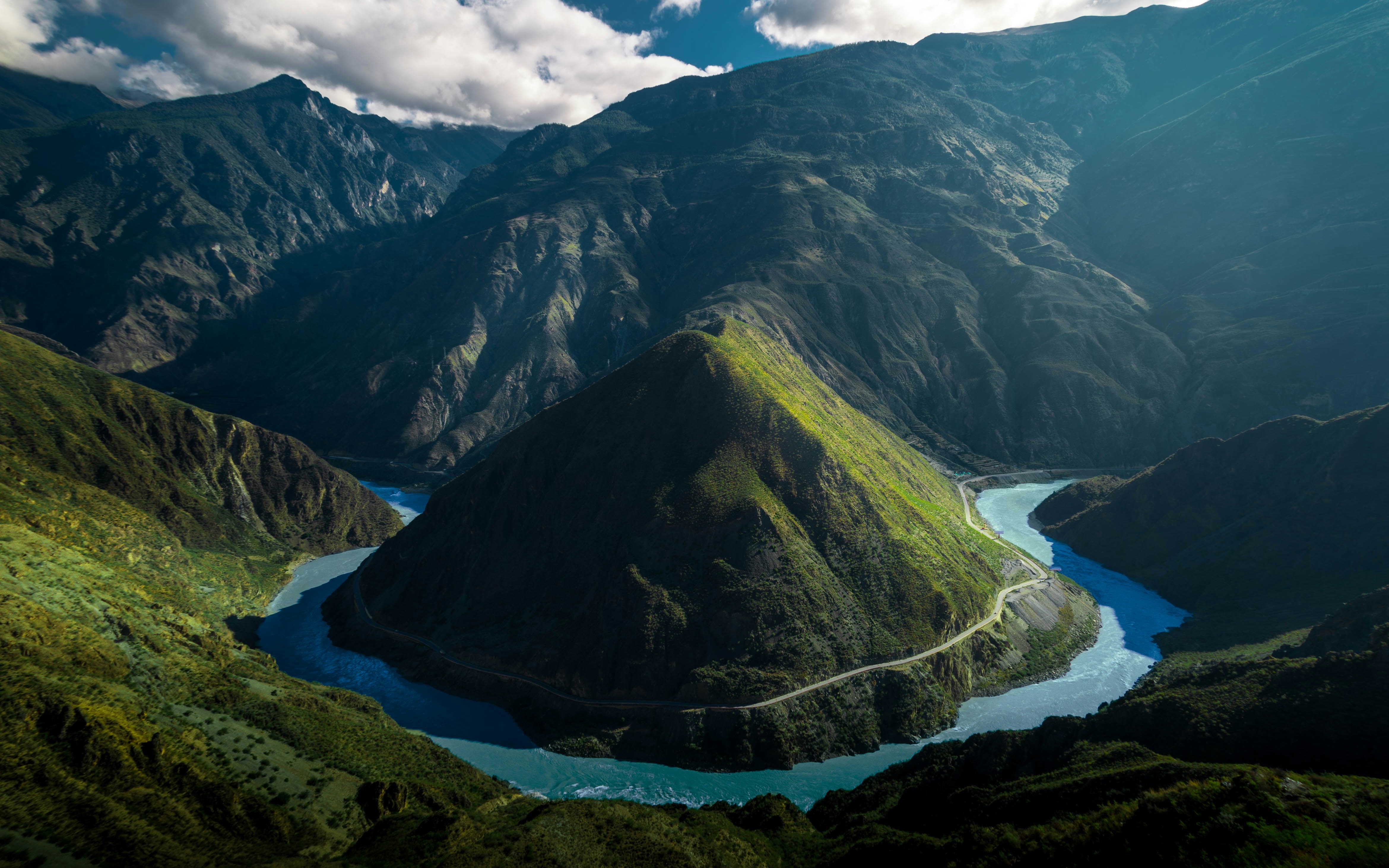 A river bends around a mountain, surrounded by valleys. photo – Free ...