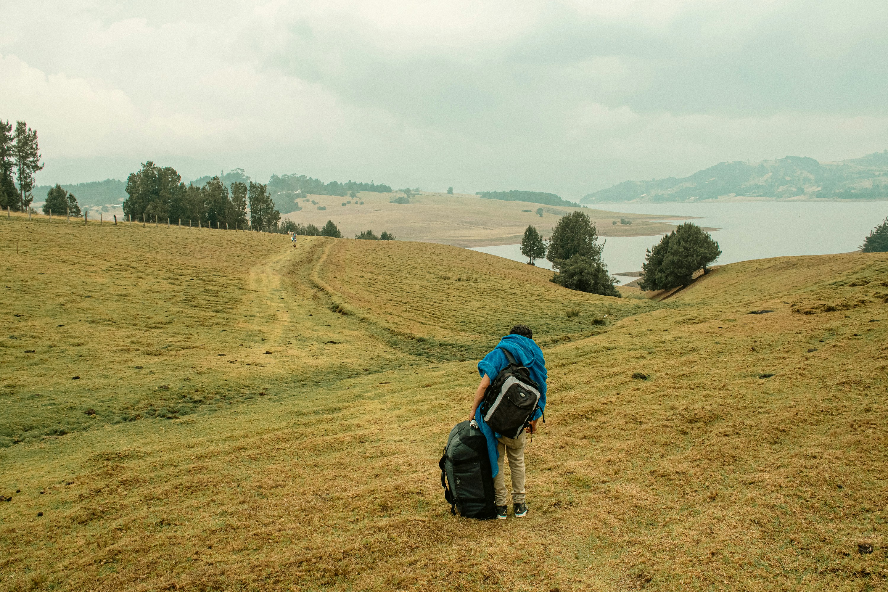 On the Ridge's Edge: A Hiker Pauses Above a Serene Lake