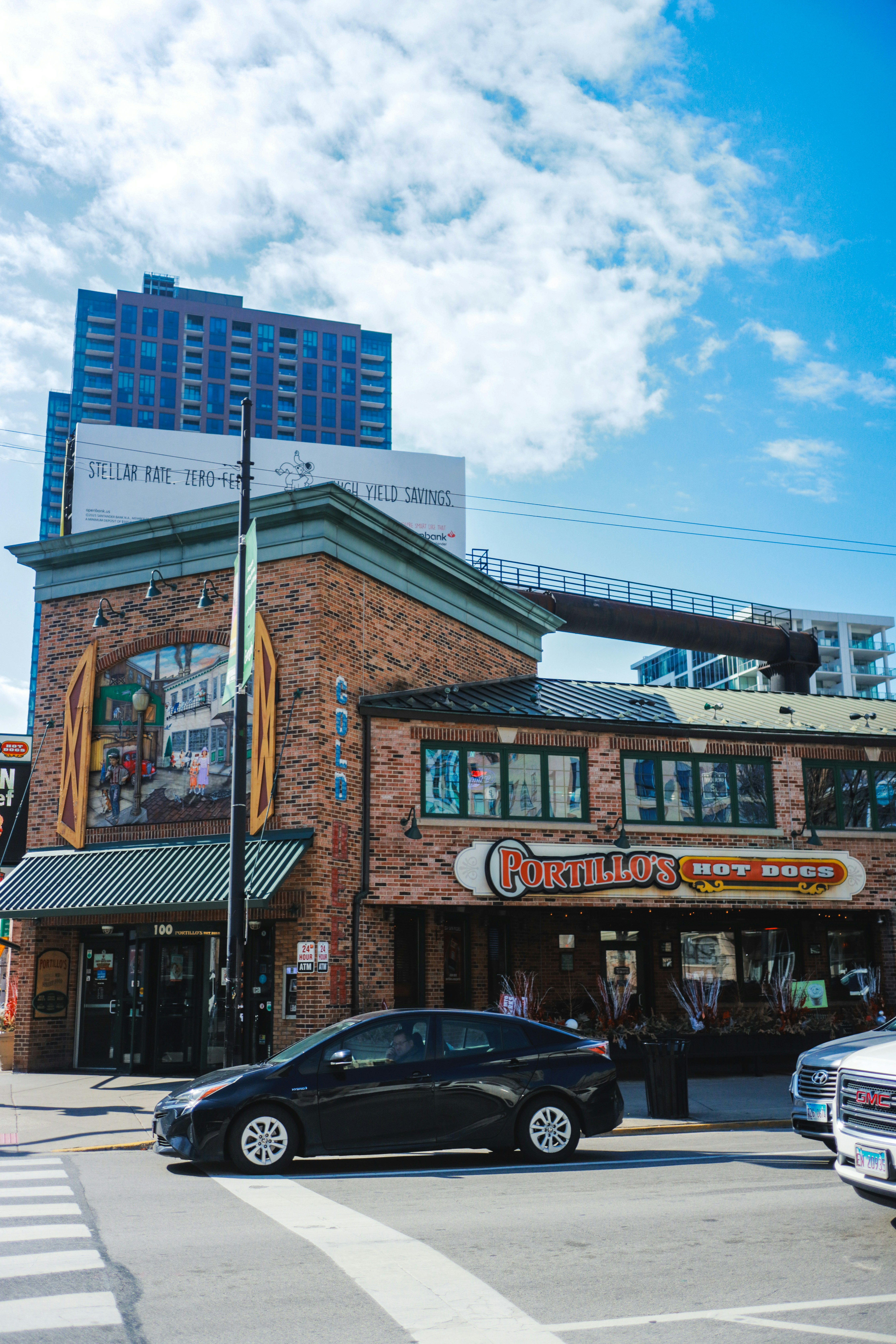 Brick Corner Rhythm: Portillo's Sign Anchors a Sunlit City Block