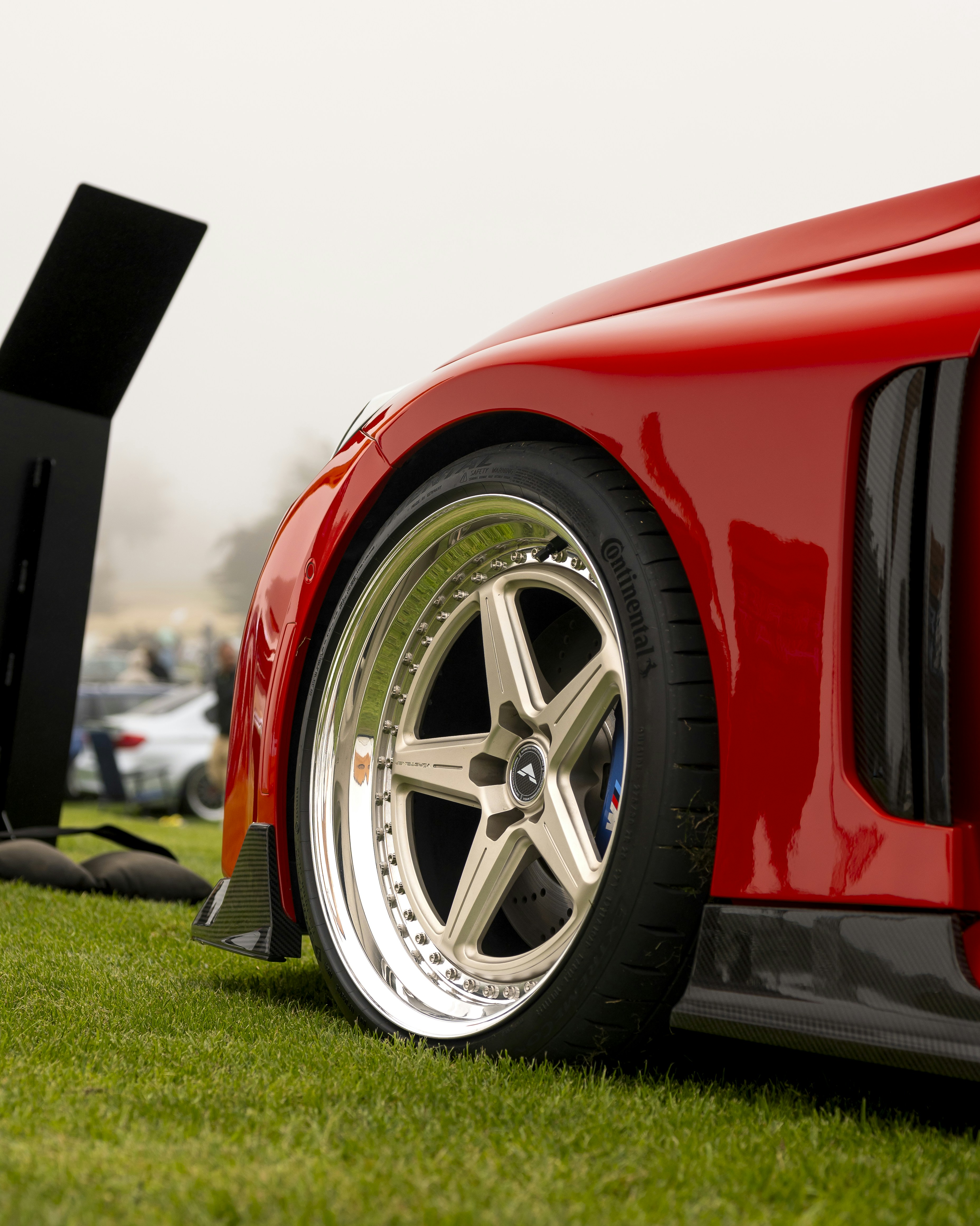 Five-Spoke Shine: A Red Show-Car Wheel in Focus