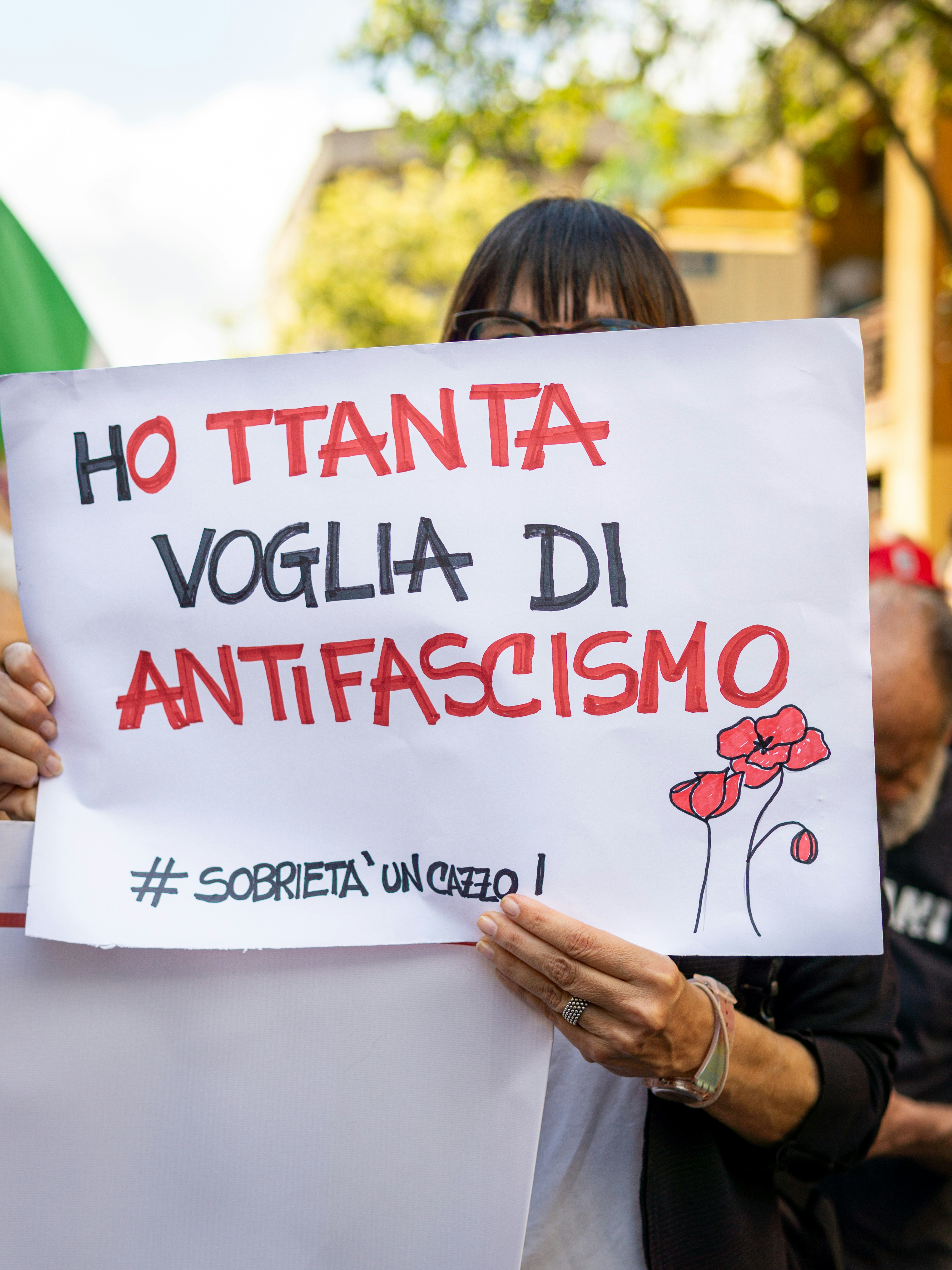 Woman holds a sign expressing anti-fascist sentiment. photo – Free Girl ...