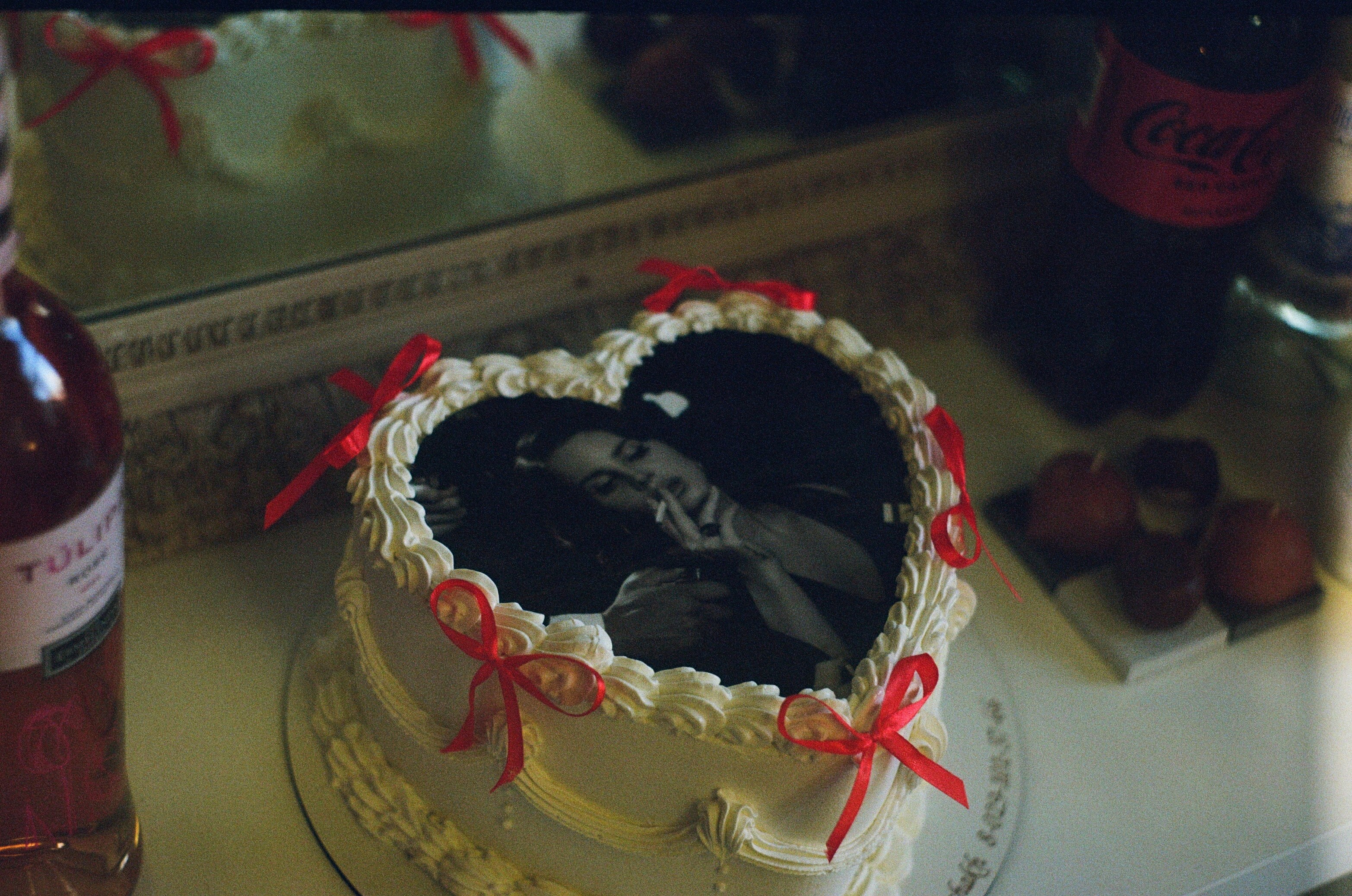 Kodak ultramax 🎞️ | A heart-shaped cake with a photograph is on display.