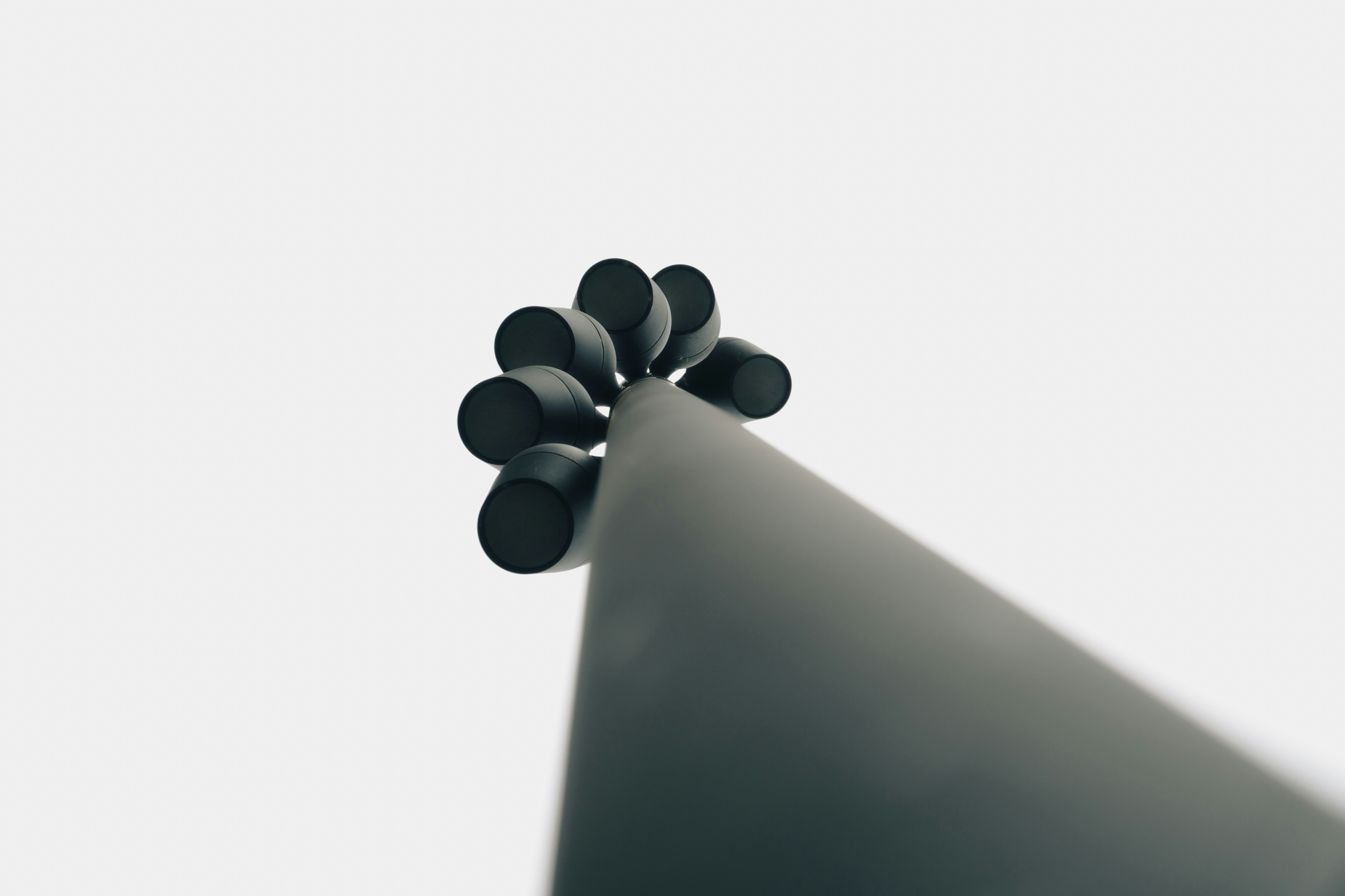 Black objects sit atop a white surface.