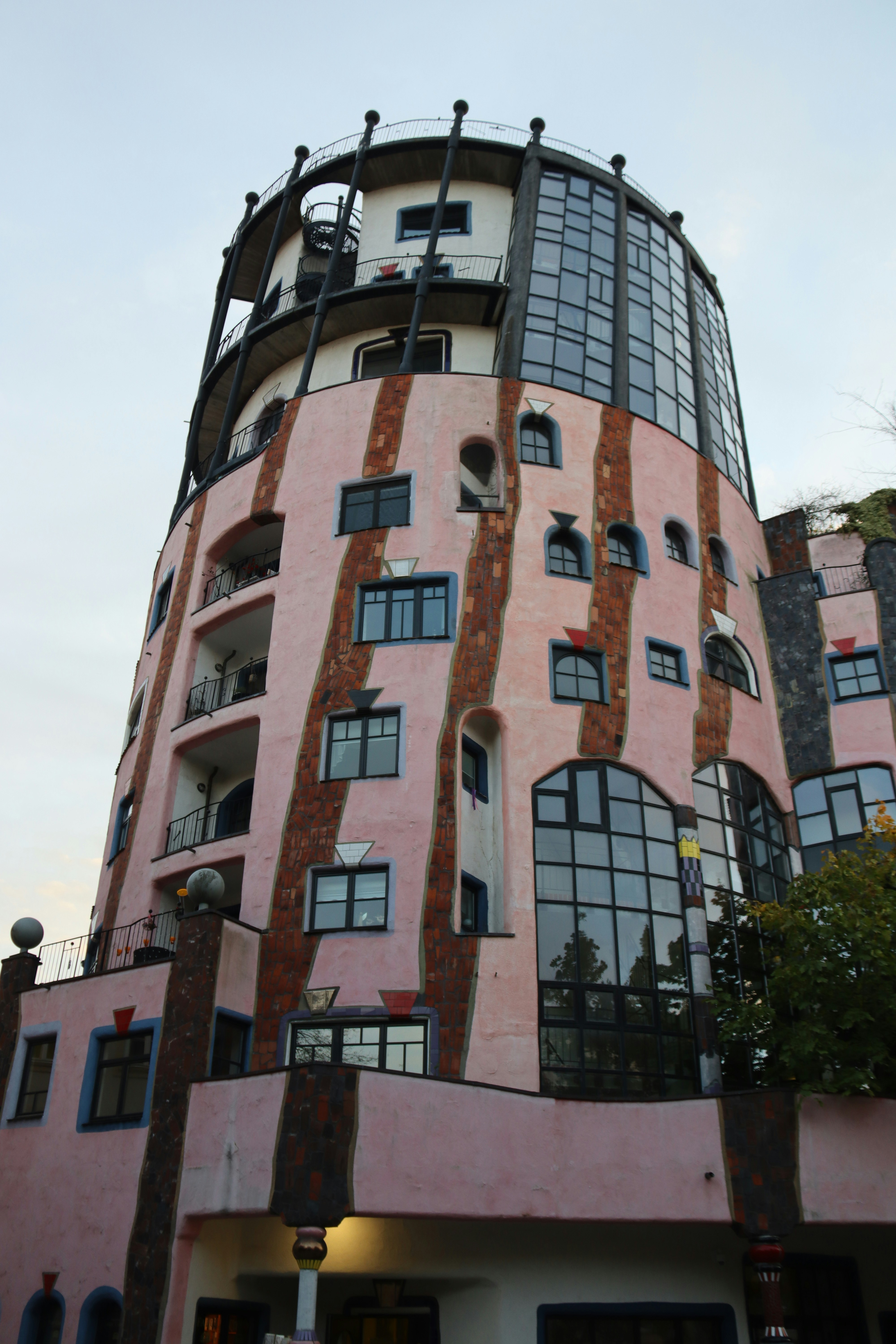 Unique building featuring a blend of vibrant colors and unconventional shapes, showcasing modern architectural creativity.