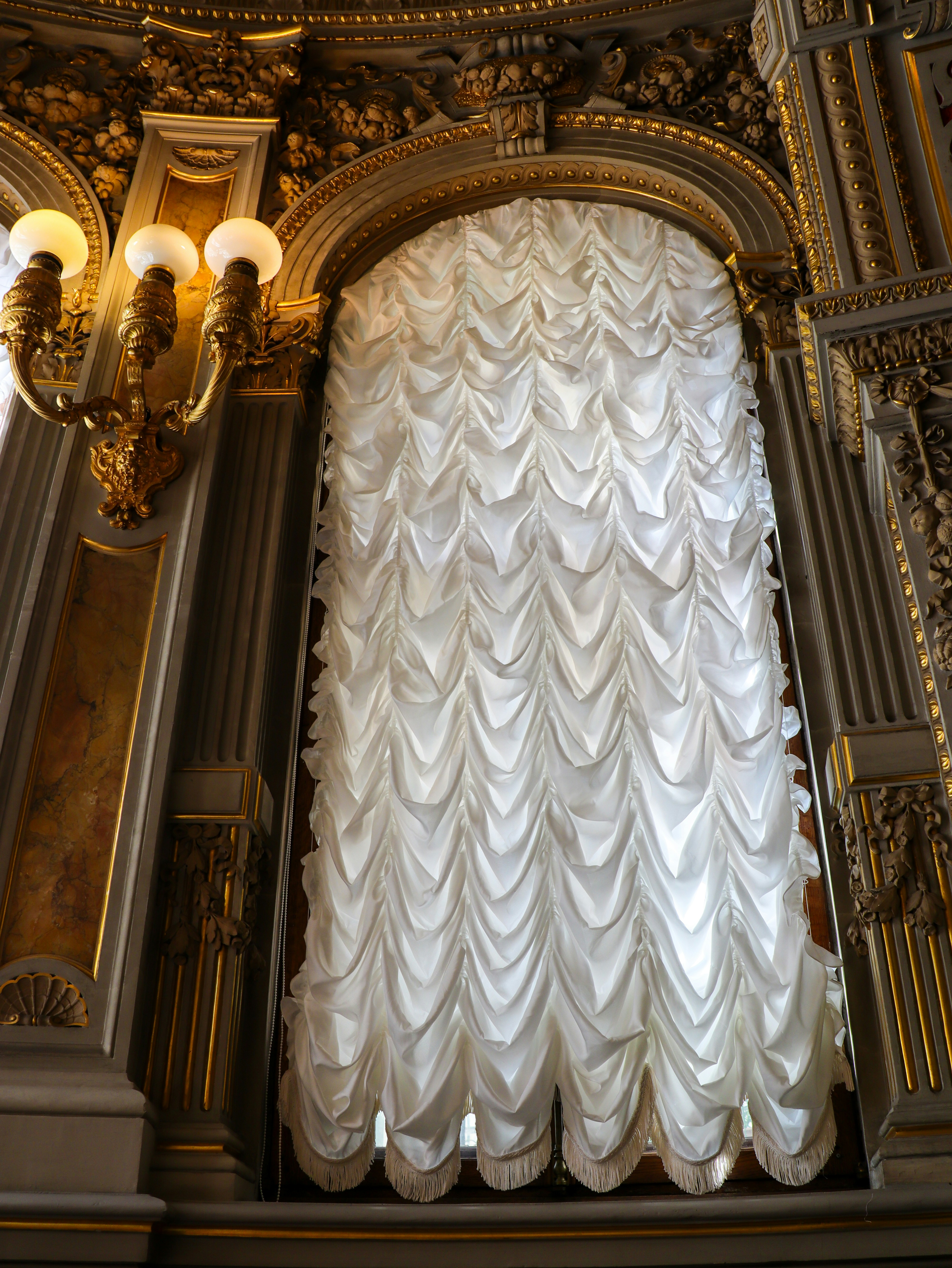 Gilded Baroque Proscenium Framing a White Draped Curtain