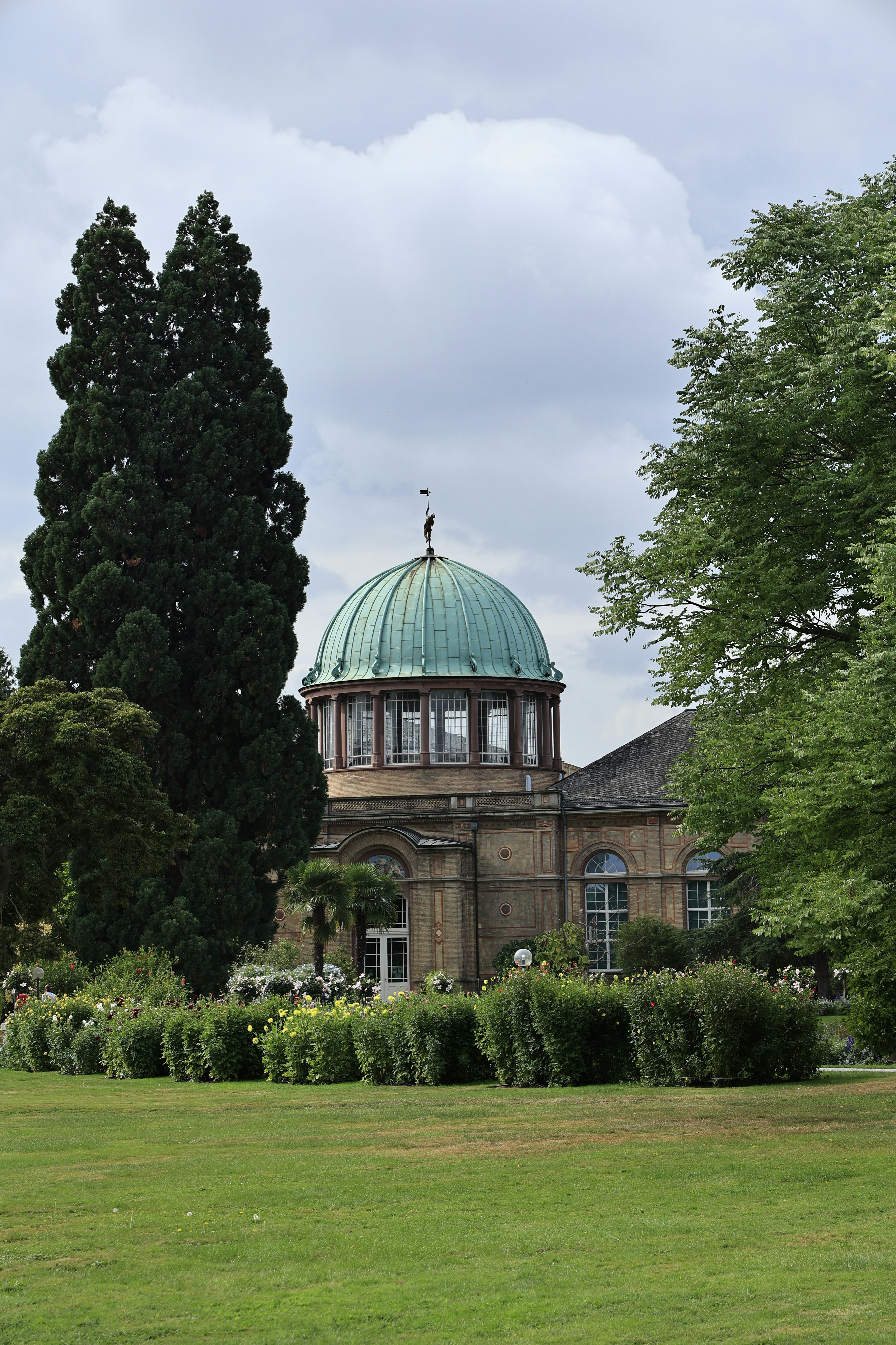 Copper Dome Amidst Greenery: A Quiet Campus Garden Scene
