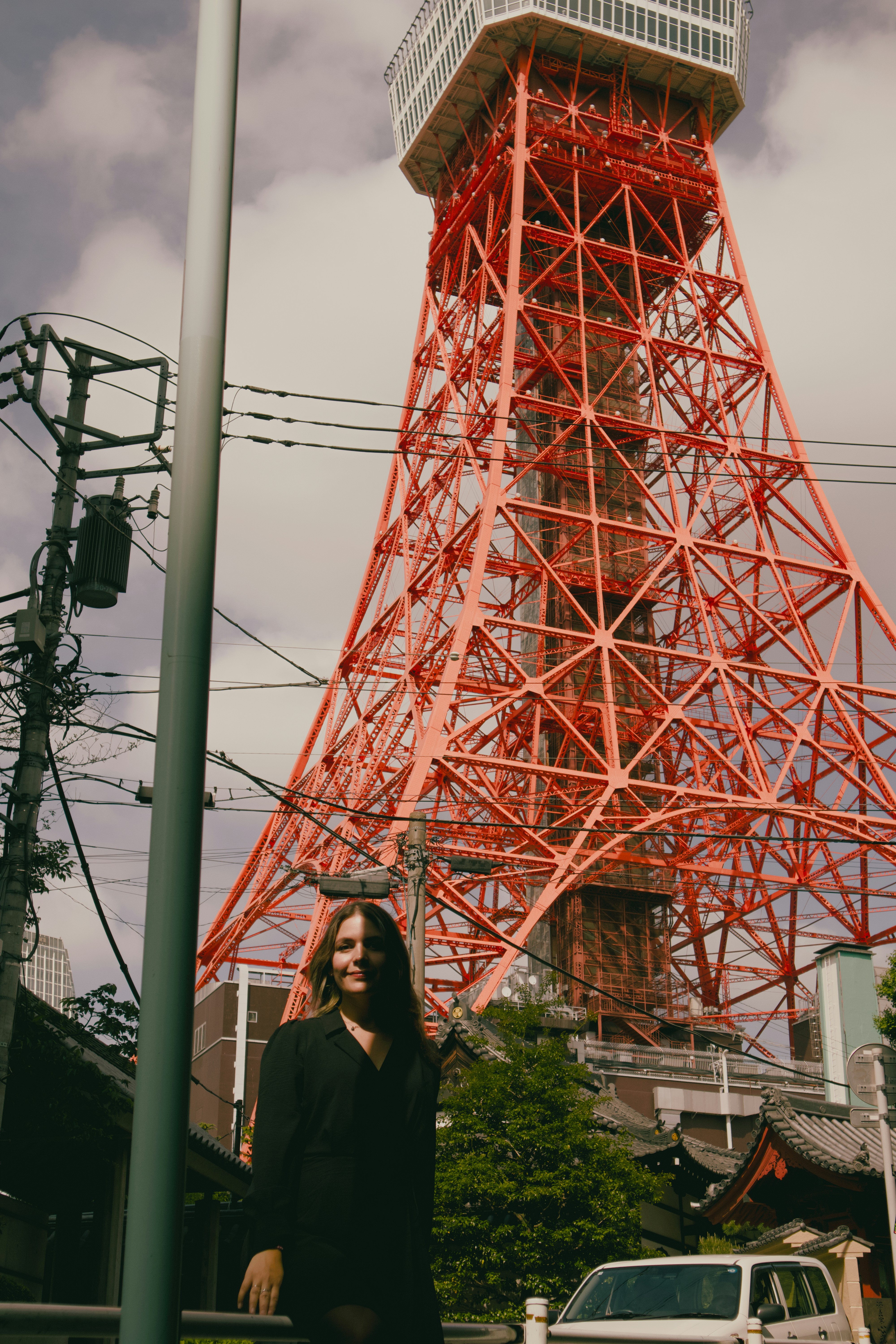 Crimson Lattice Over Quiet Streets: Tokyo Tower Framing a Street Portrait