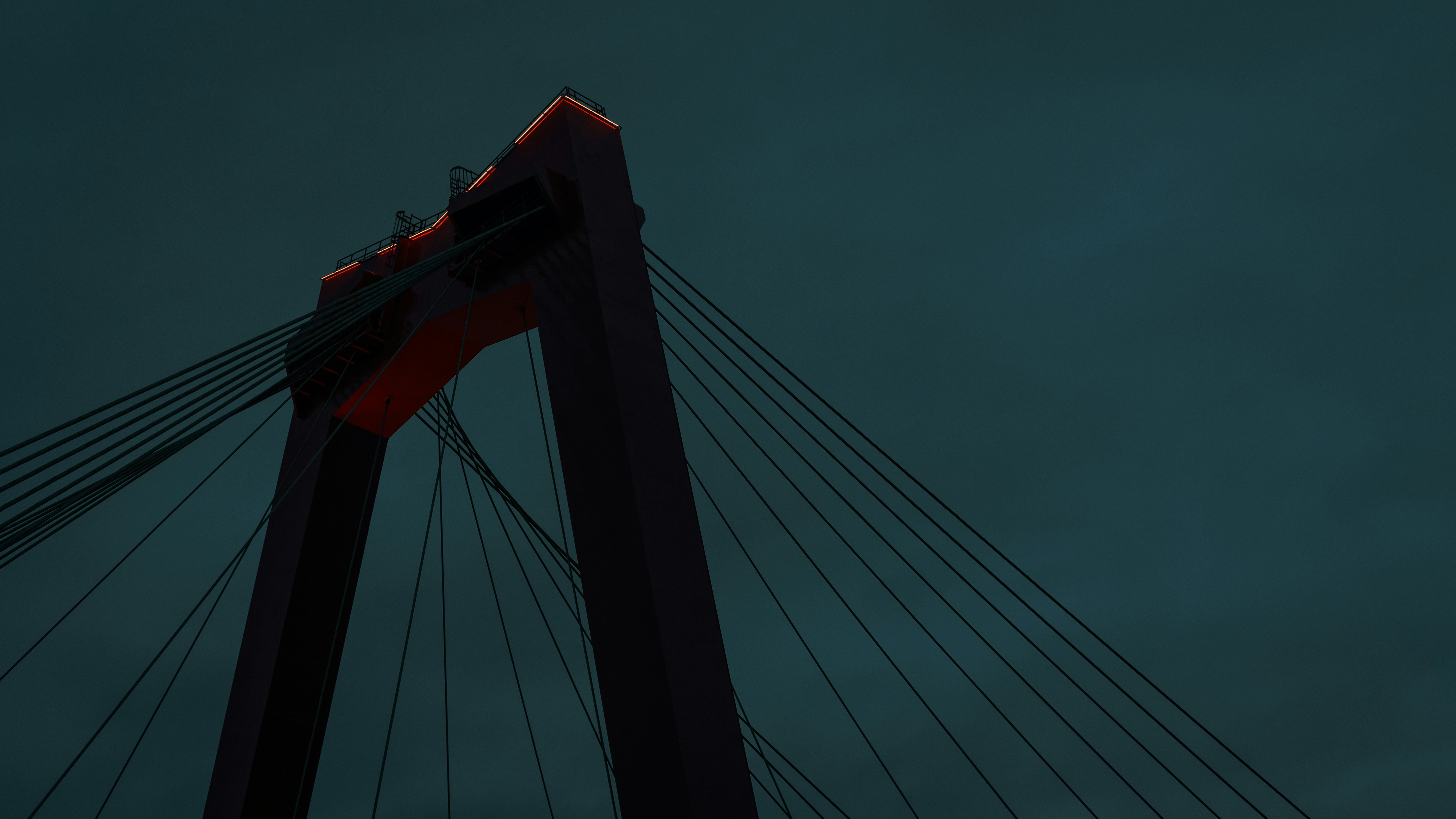 Midnight Span: The Cable-Stayed Pylon Piercing a Teal Sky
