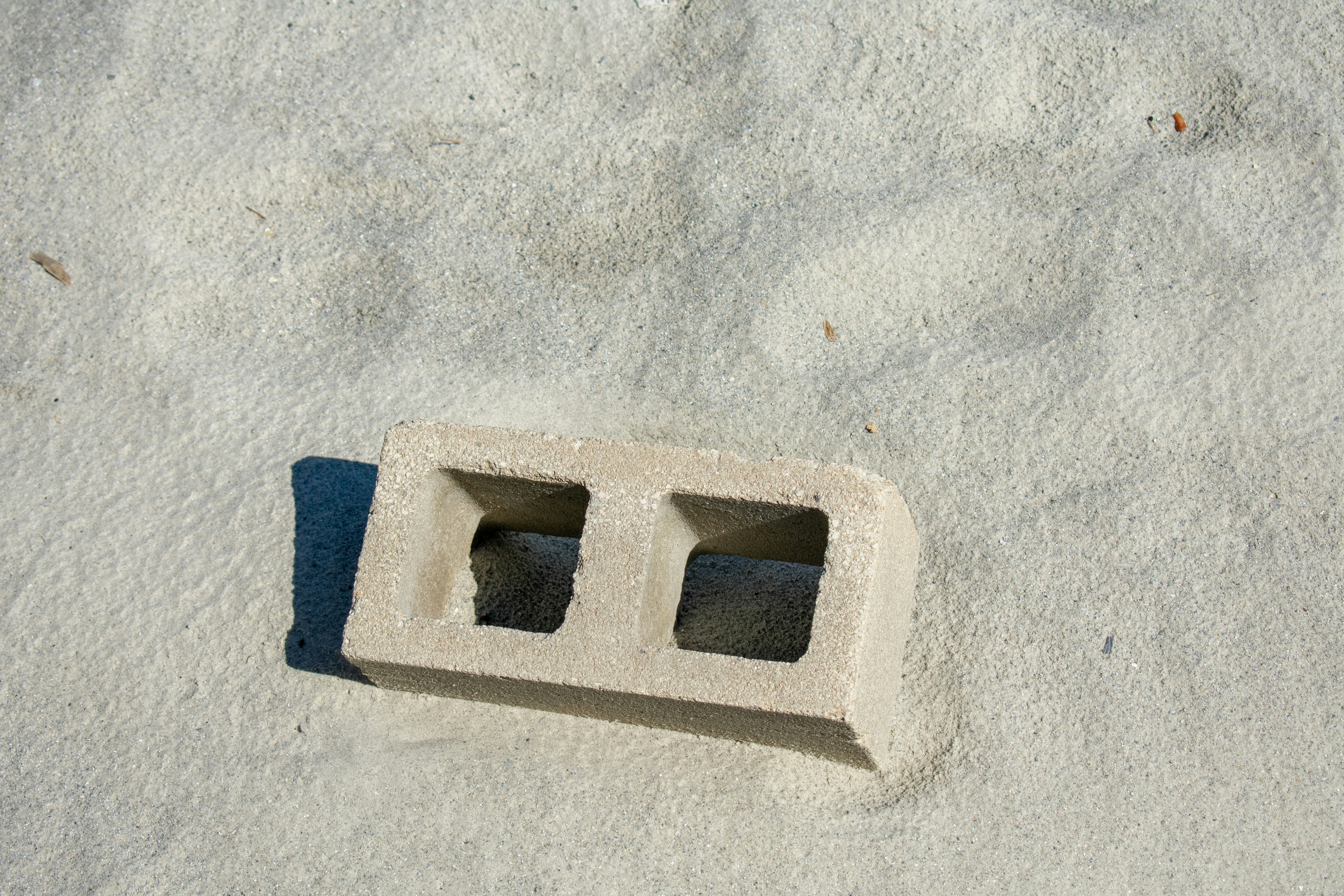 Two-Hole Concrete Block Resting on Snow