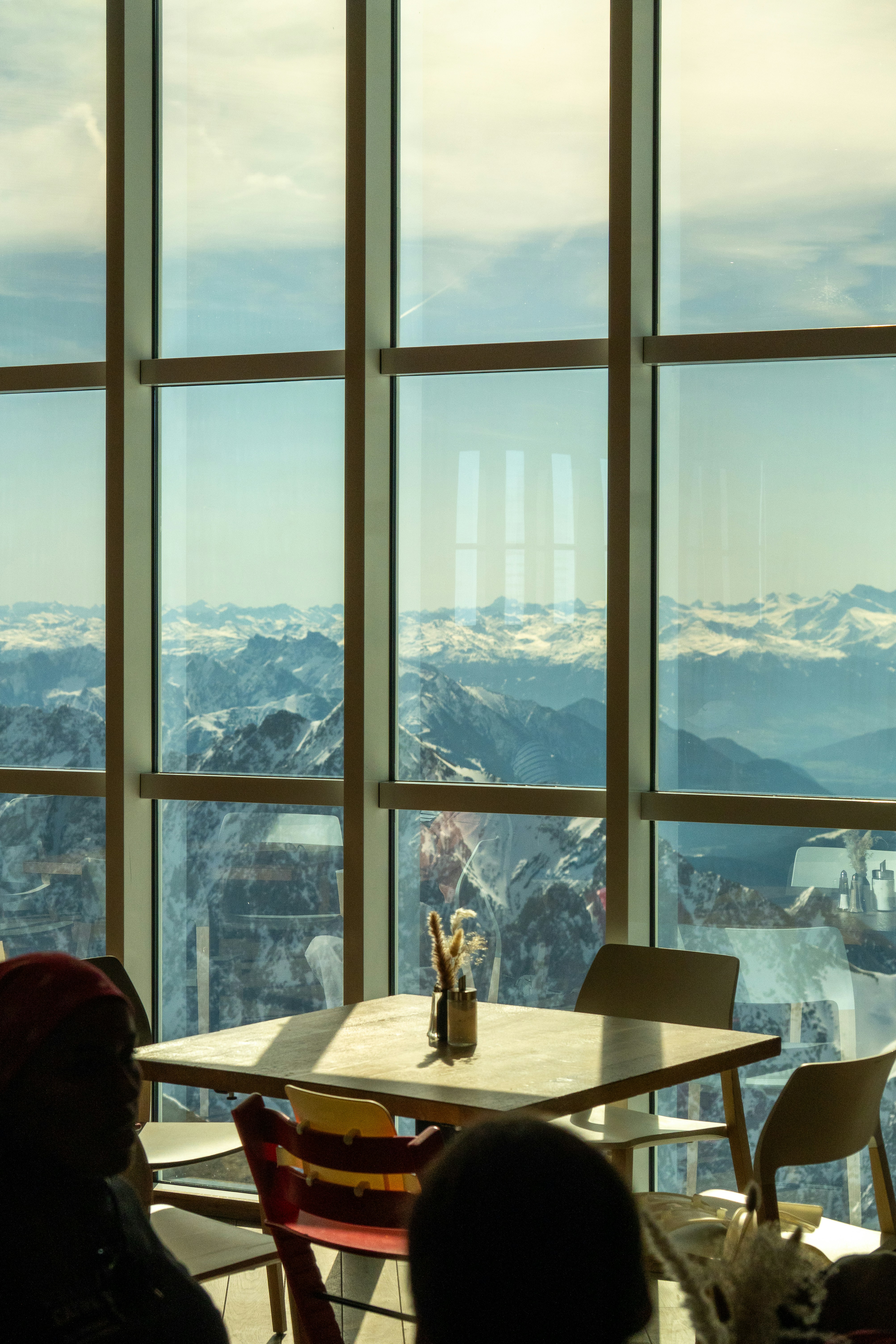 Windowed Summit Café: Morning Light over Glacial Peaks
