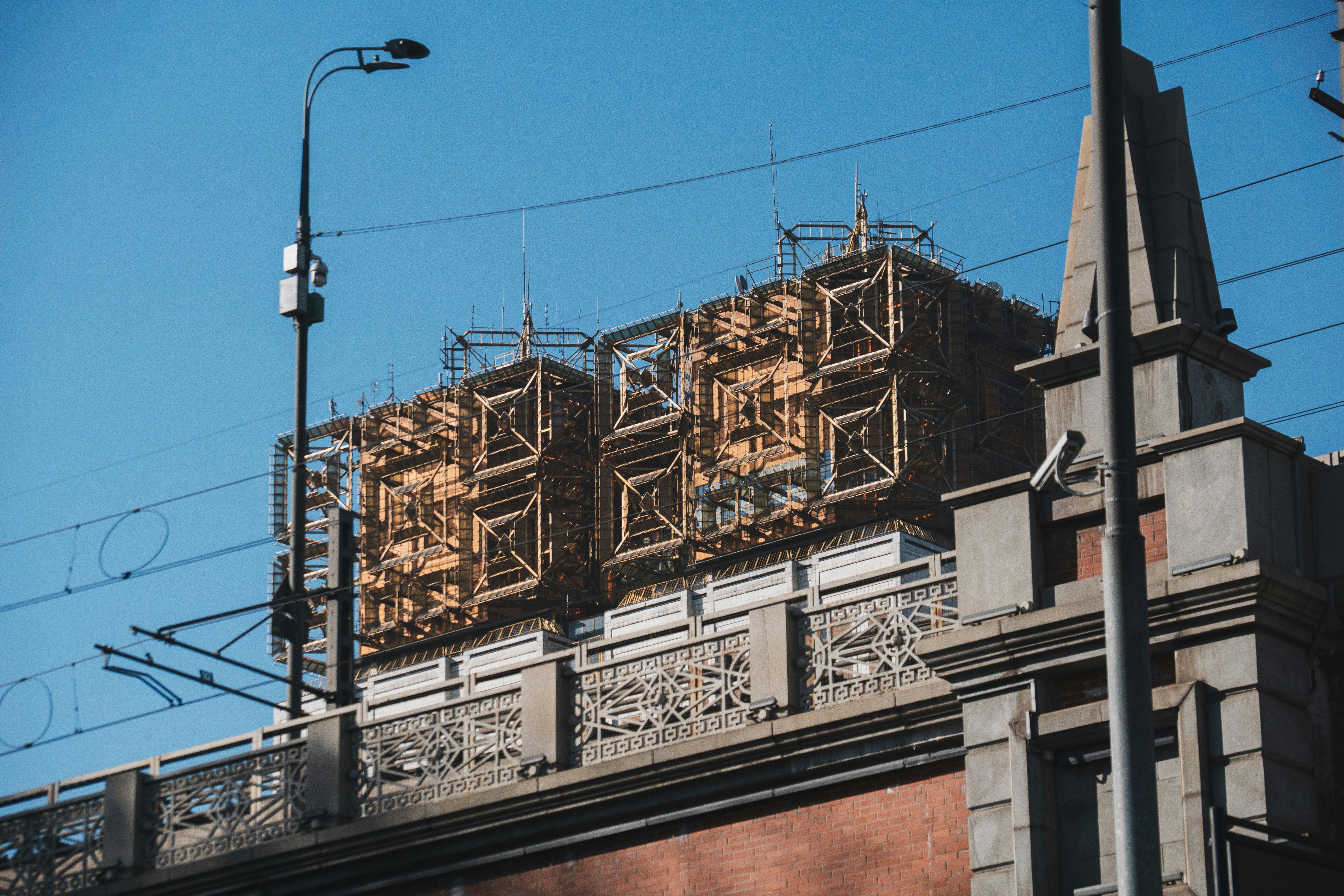 Cobalt Sky Crowned by Scaffolding on a Historic Facade