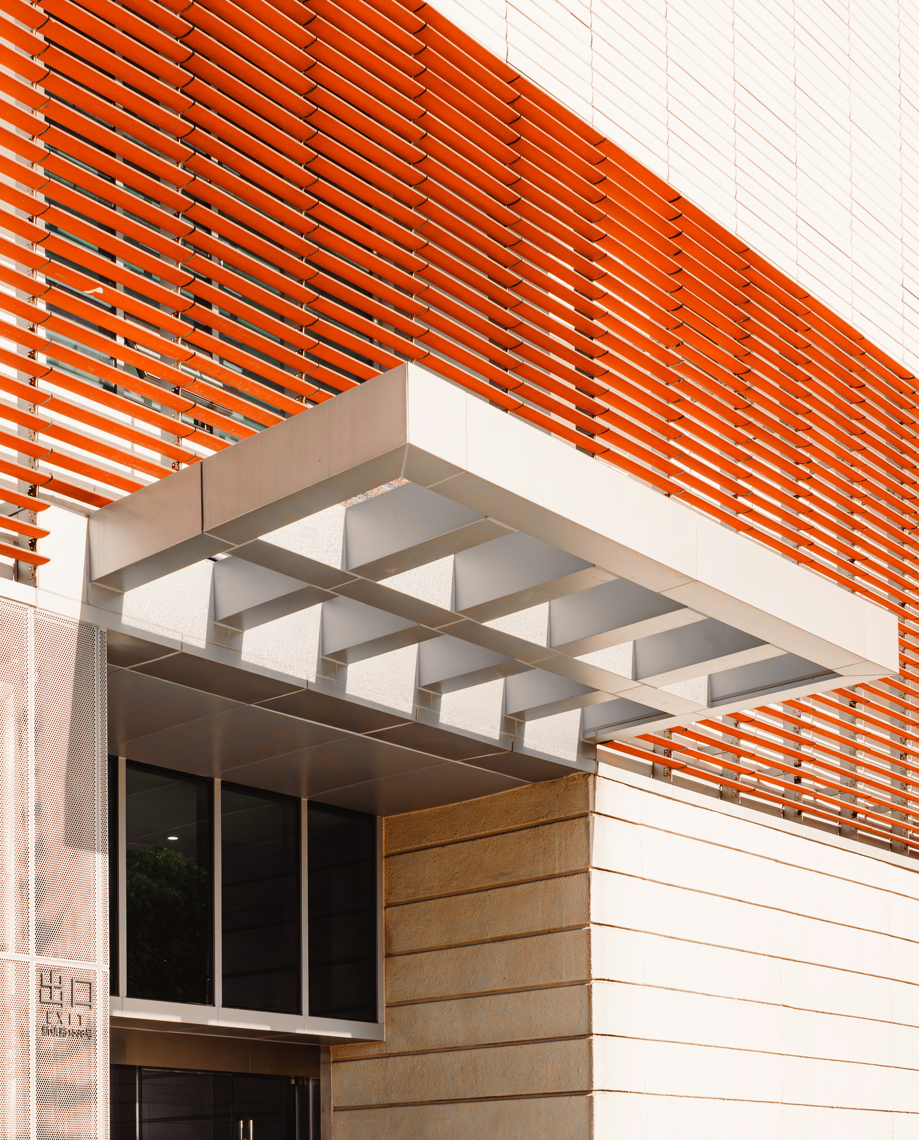 Architectural Lines: Orange Louvers and Geometric Canopy