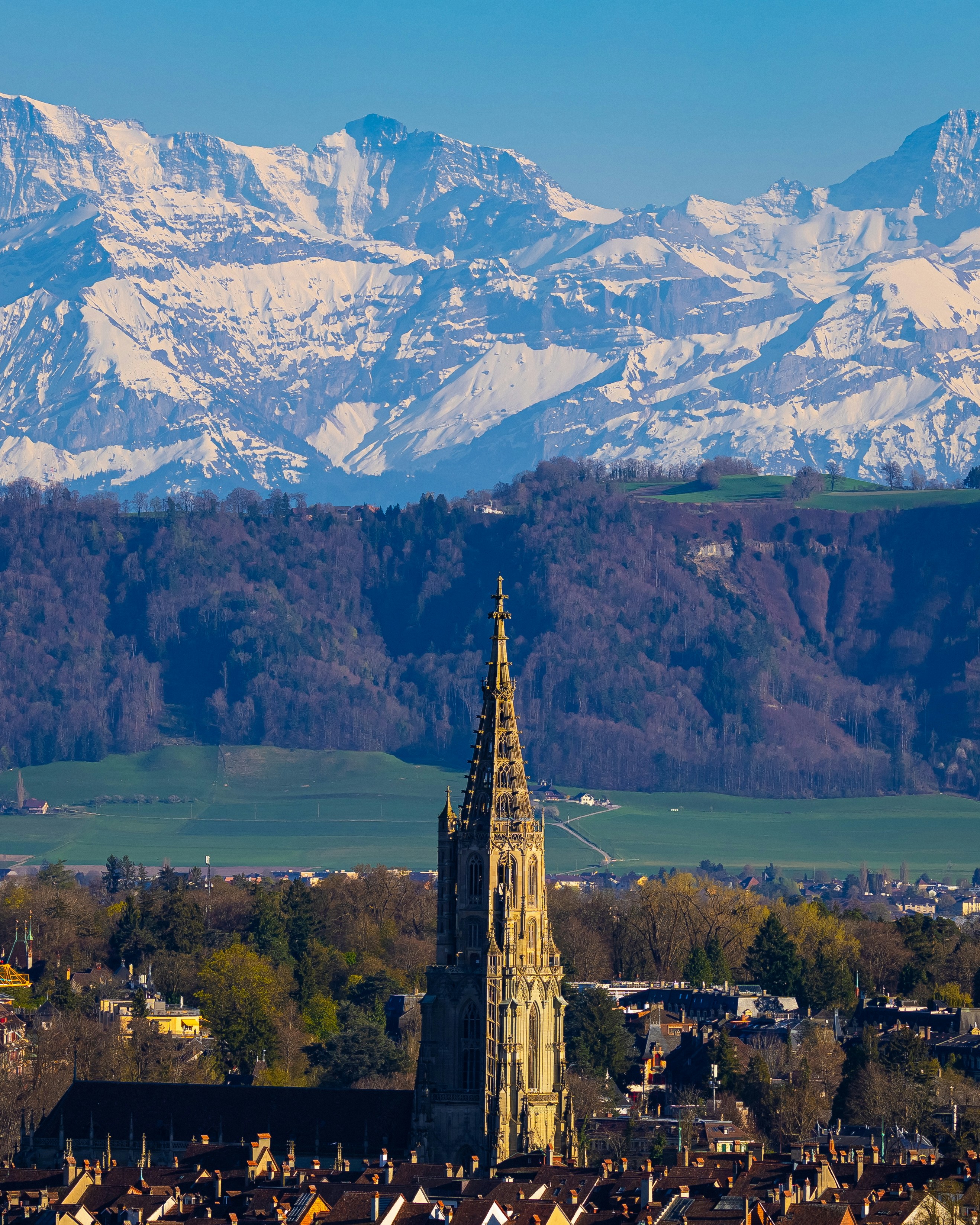 Gothic Spire Against Majestic Peaks