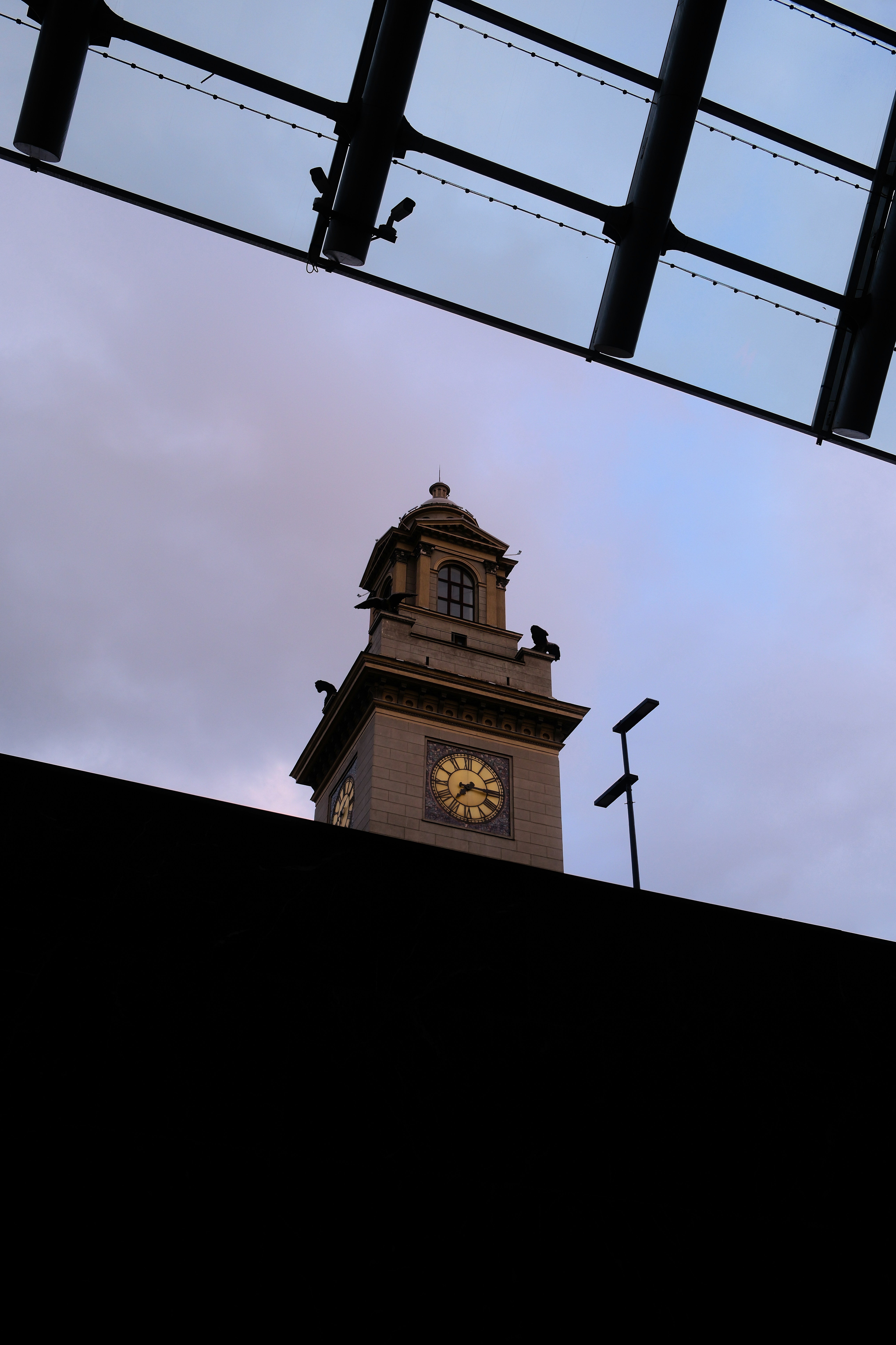 A clock tower peeks above the building structure. photo – Free Clock ...