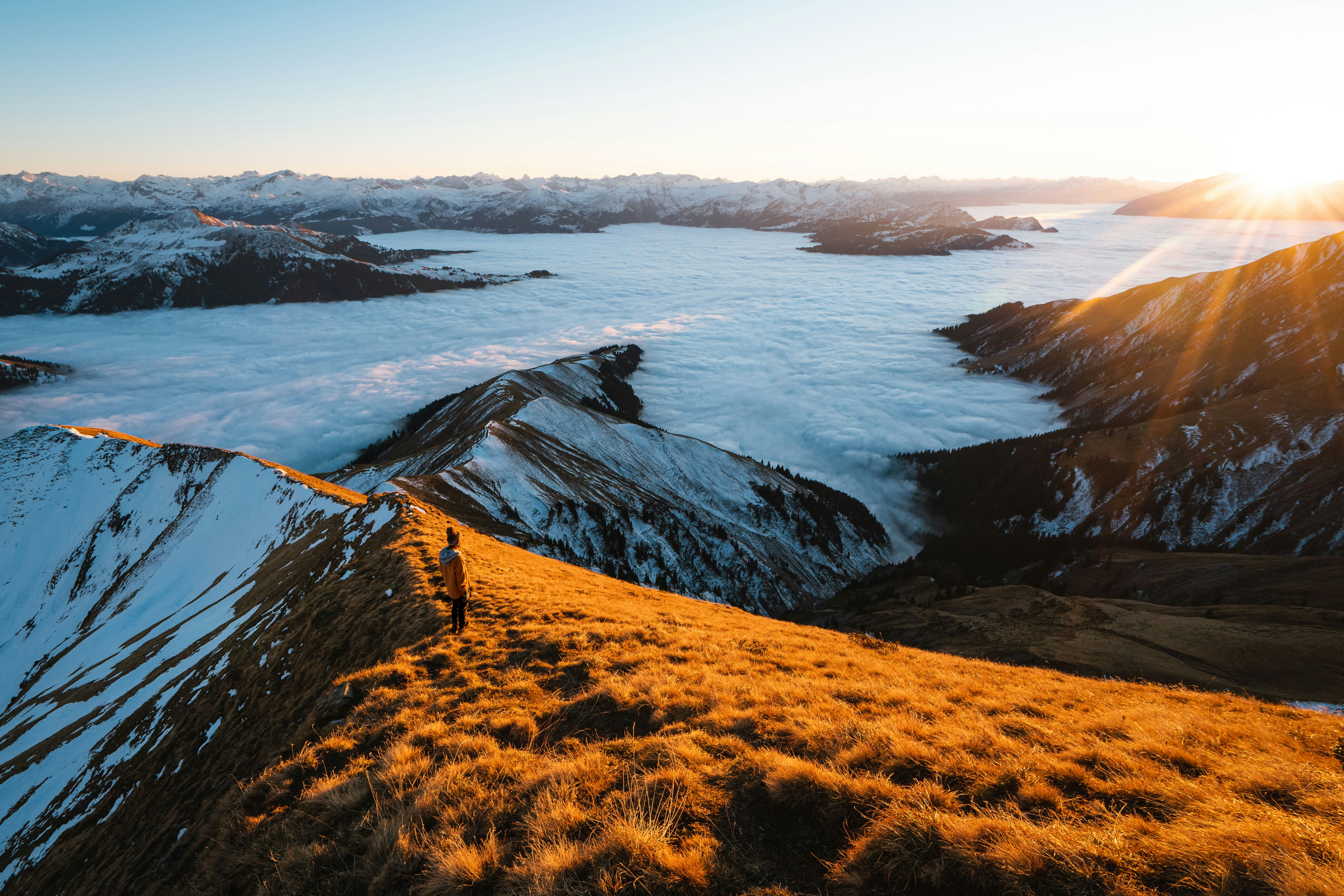Sunlit Ridge: A Solo Traveler Overlooking a Cloud Sea at Dawn