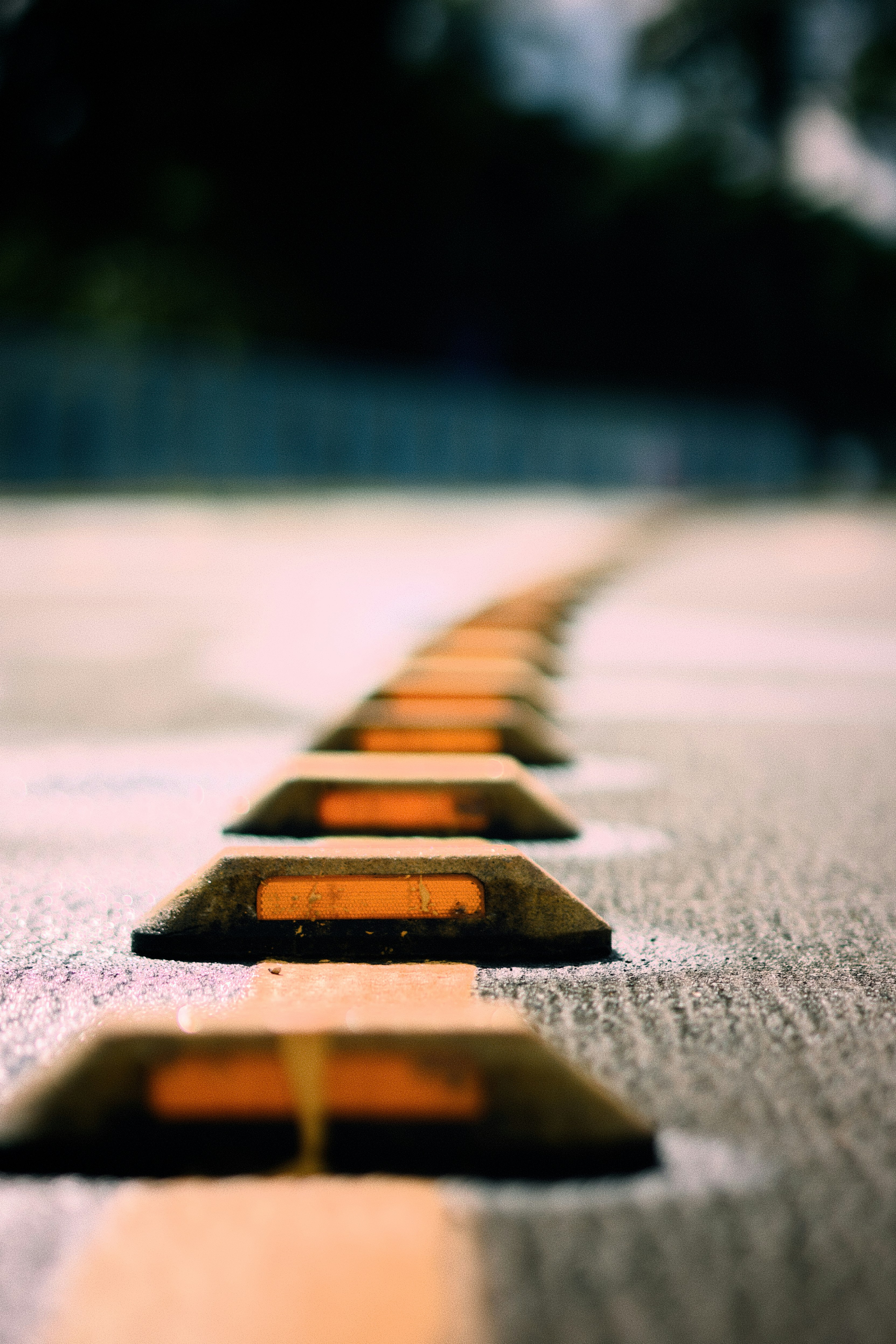 Amber Beacons Stretch Along a Sunlit Pavement: A Low-Angle Perspective