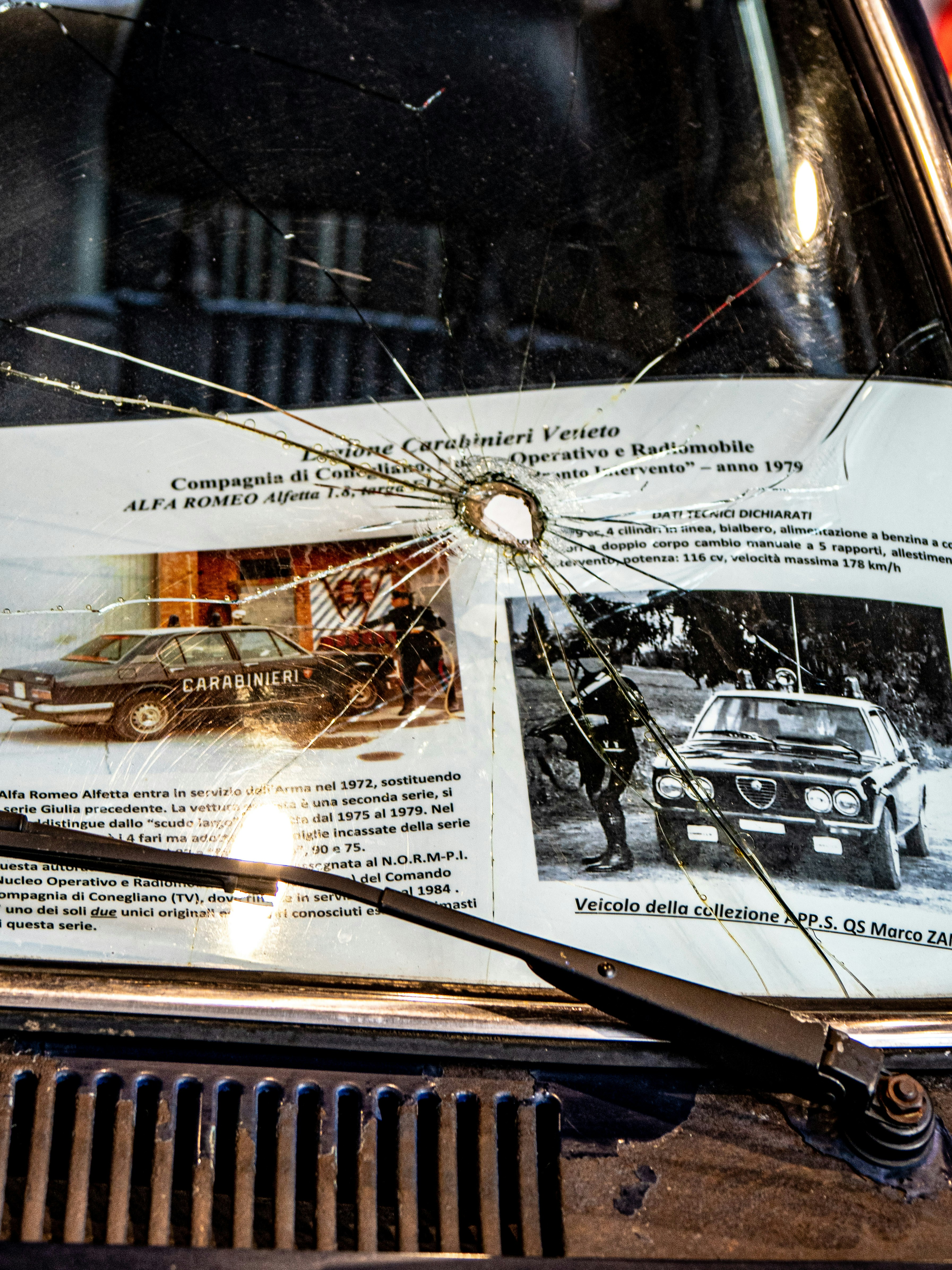 Bullet-Holed Window Chronicle: Cracks Framing a Carabinieri Magazine Spread
